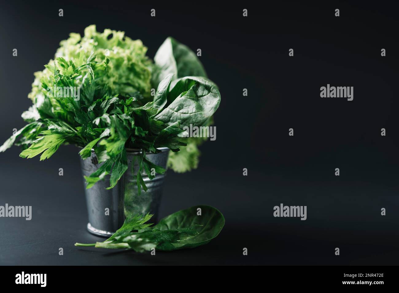 organic leafy vegetables bucket black background. High resolution photo ...
