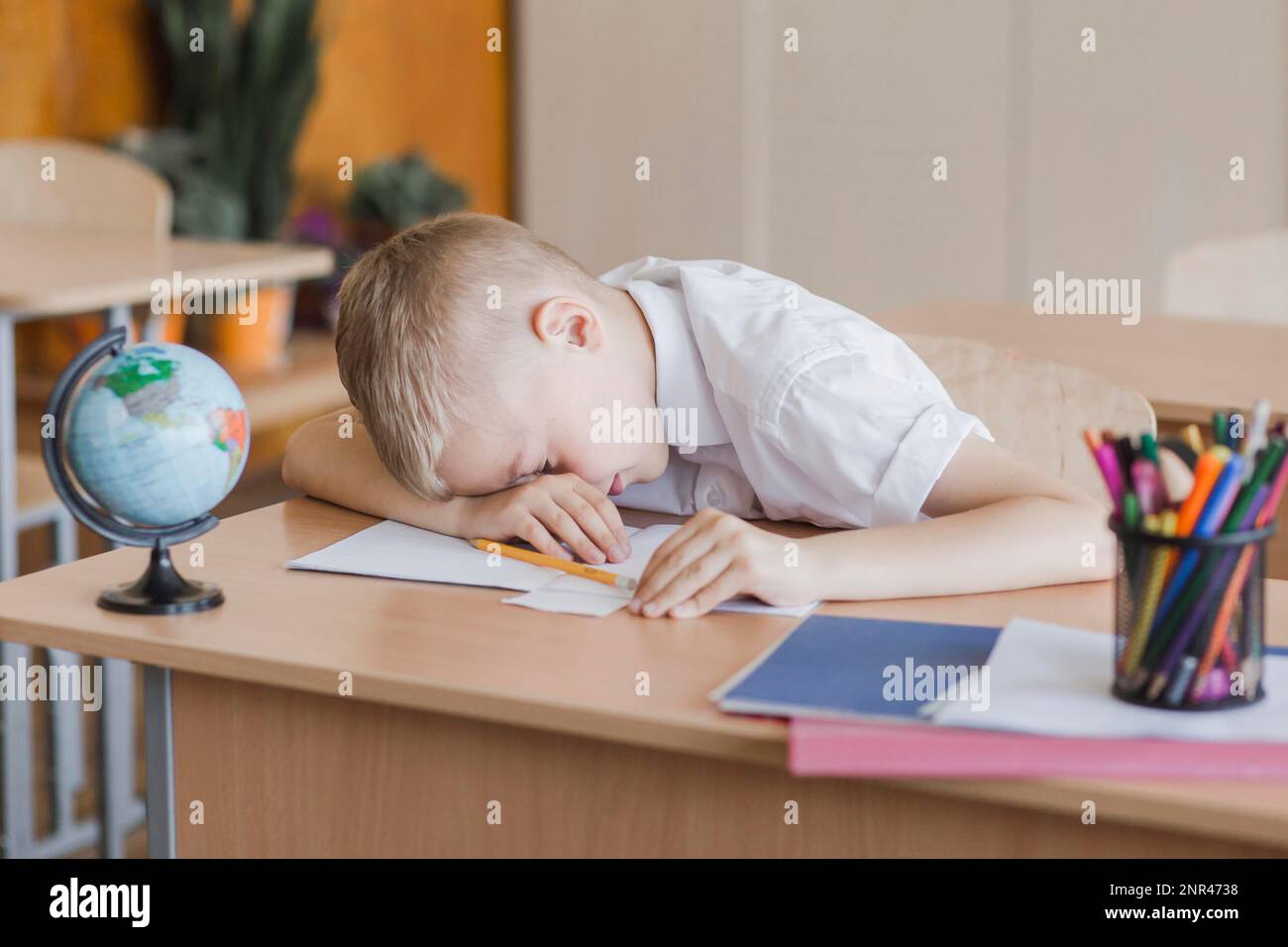 little pupil laying table classroom. High resolution photo Stock Photo ...