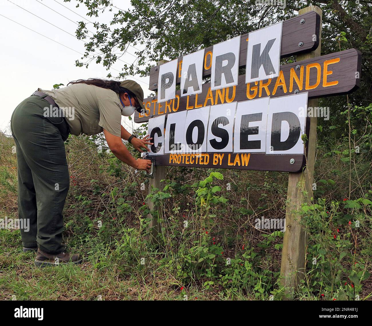 Park employee Stephanie Zepeda prepares sign at the Estero Llano Grande ...