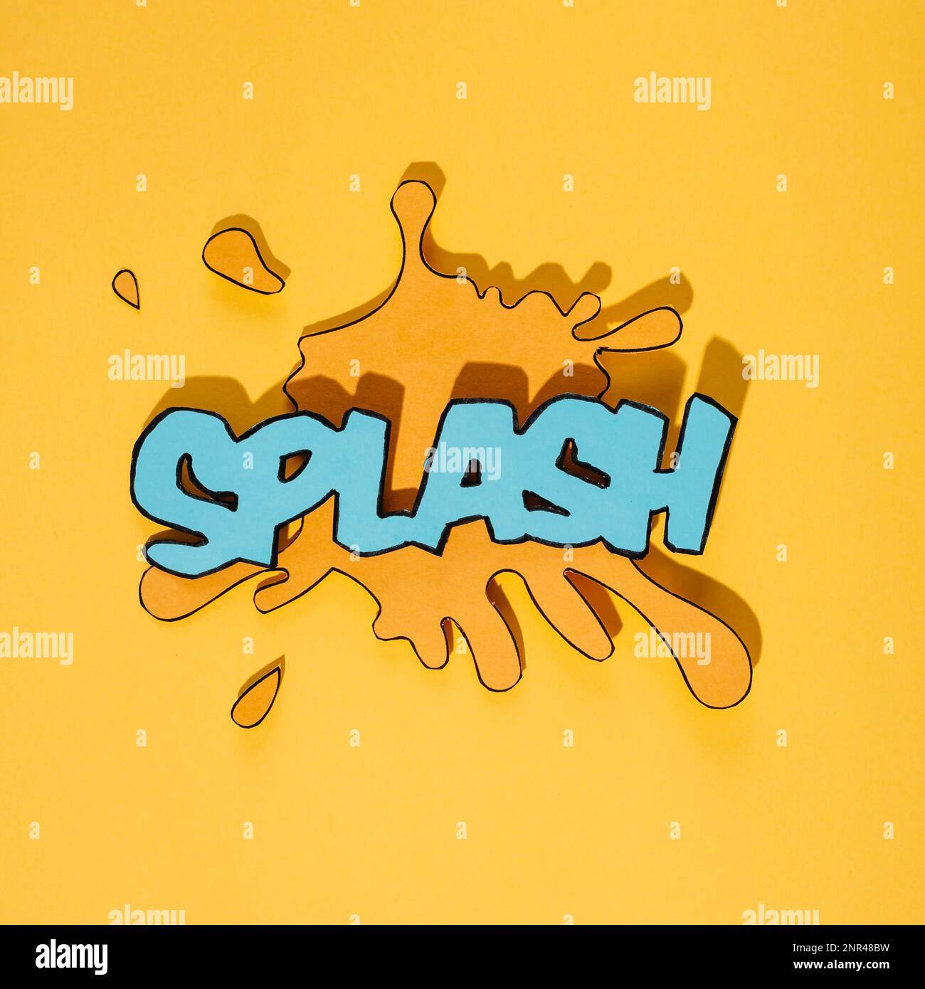 blue splash text blot against yellow background Stock Photo - Alamy
