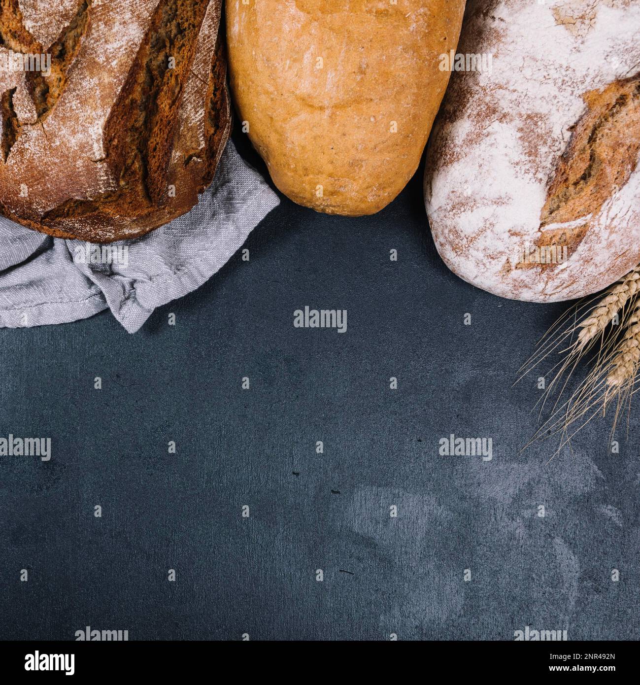 Overhead view rustic loaf breads black counter top Stock Photo - Alamy