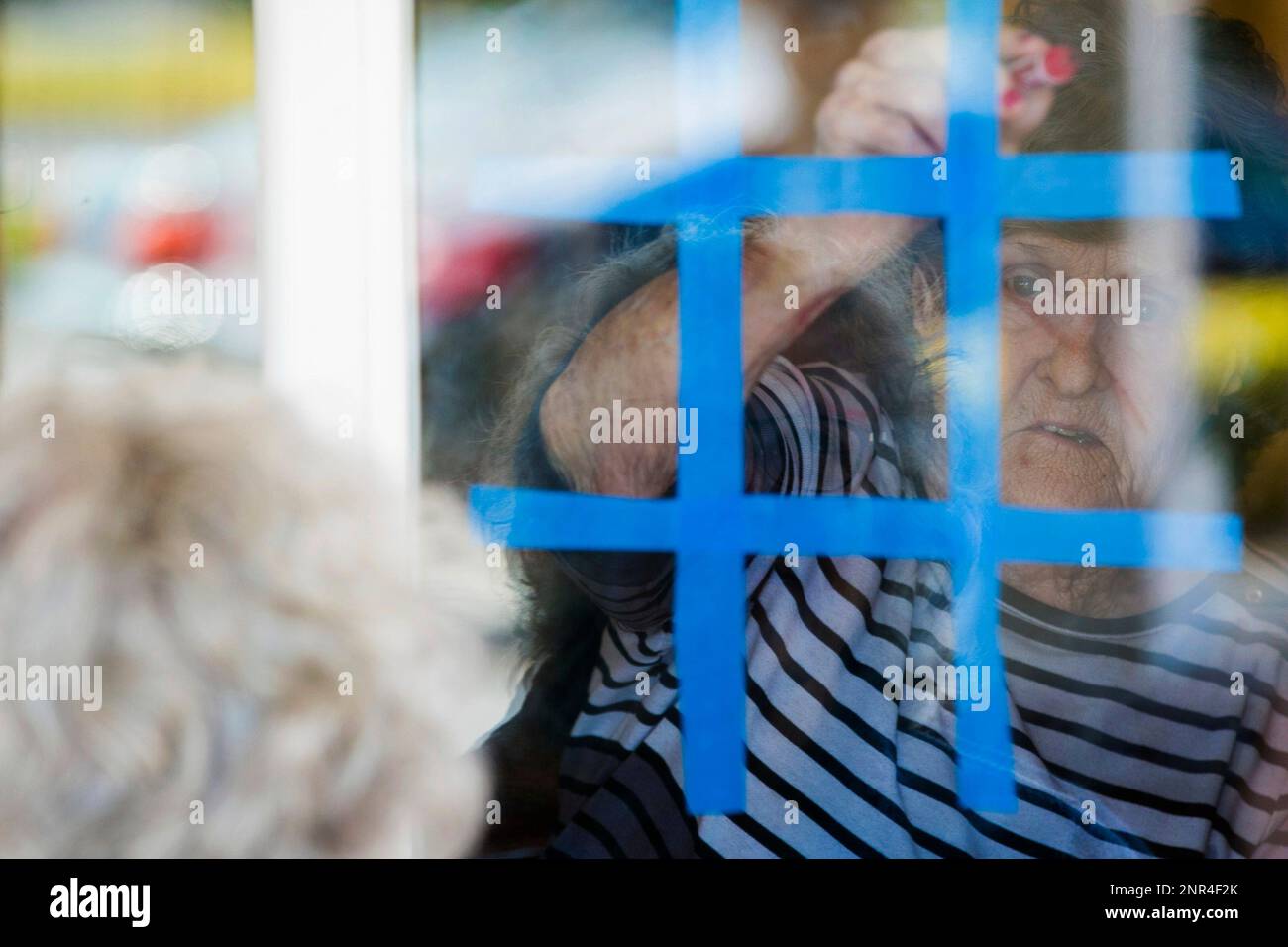 Norma Hickman makes a move playing tic-tac-toe against Sheri Martin on ...