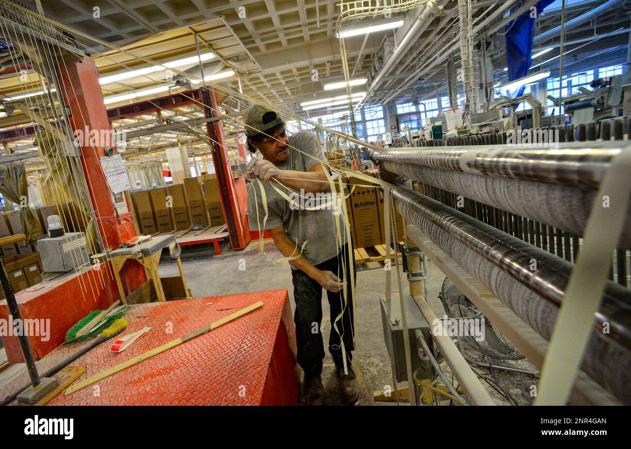 Keith Fanum, slitting operator at Fulflex, in Brattleboro, Vt., strings ...