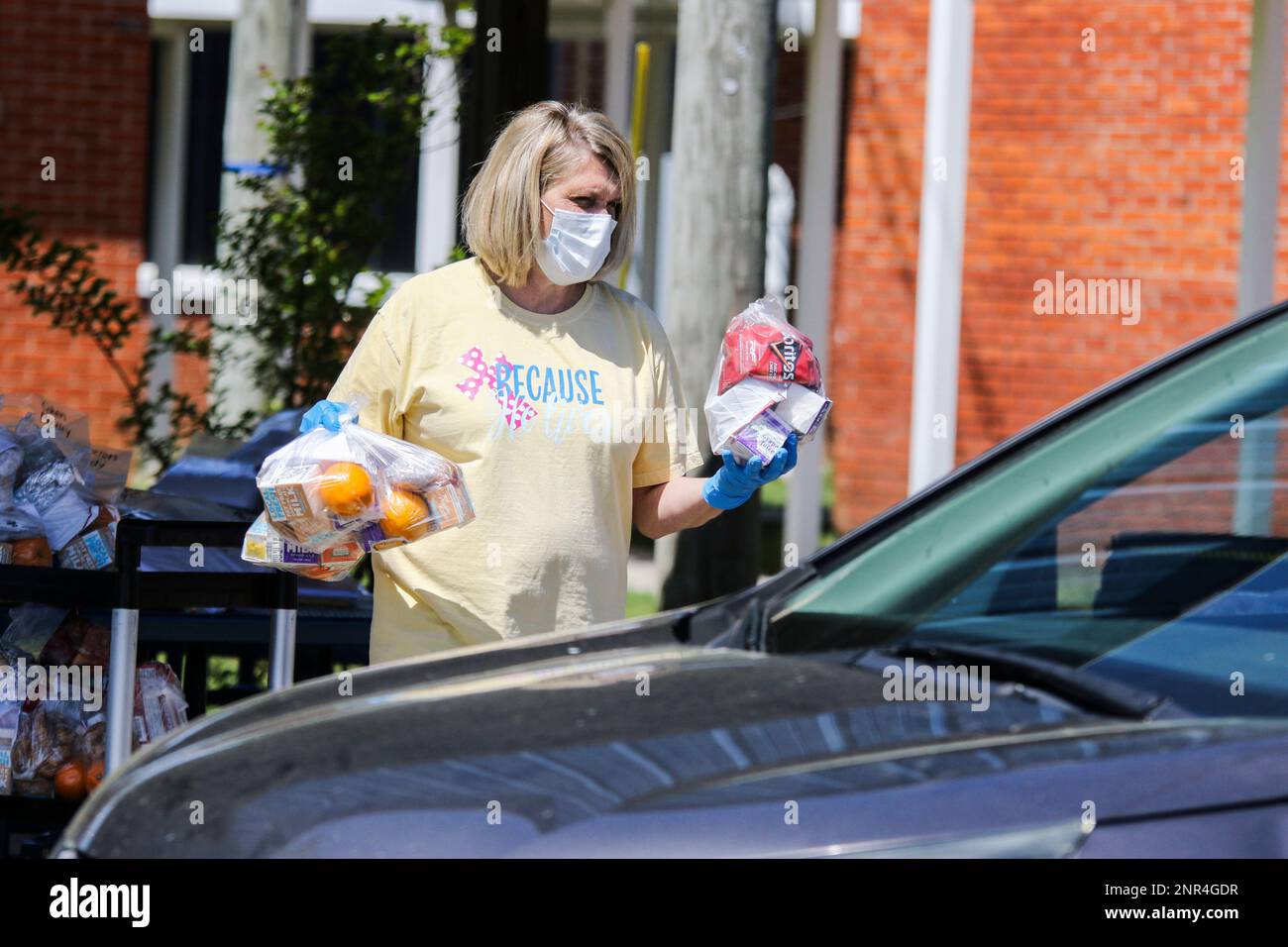 Sheri Culpepper passes out sack lunches as parents drive through the ...