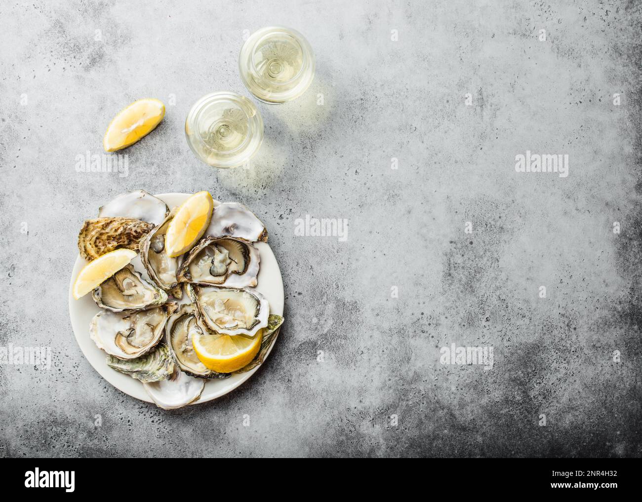 Close-up of half dozen of fresh opened oysters and shells with lemon ...
