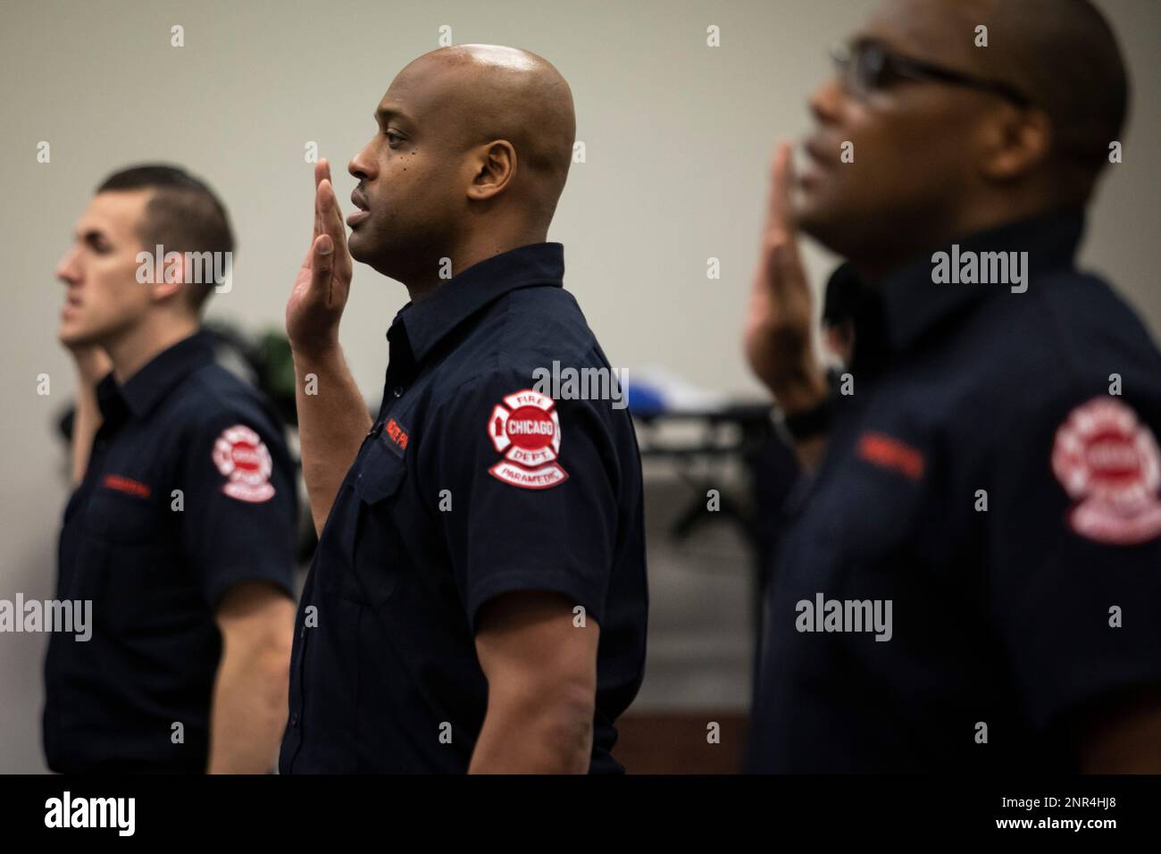 Earl Digby Jr. (center) takes the oath of office during the graduation ...