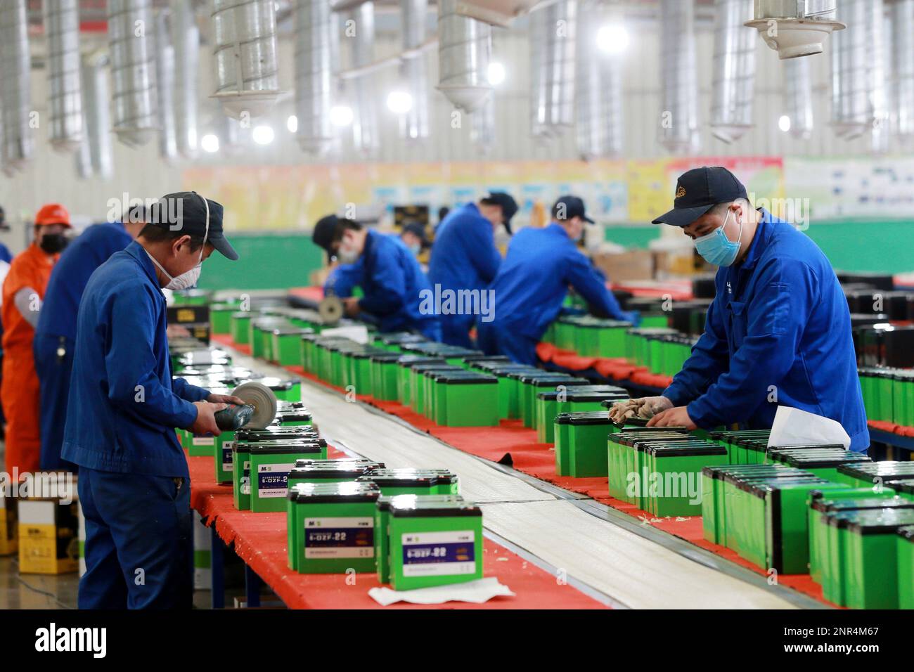 Masked workers labor in a factory of lead-acid batteries in Suixi county in central China's ...