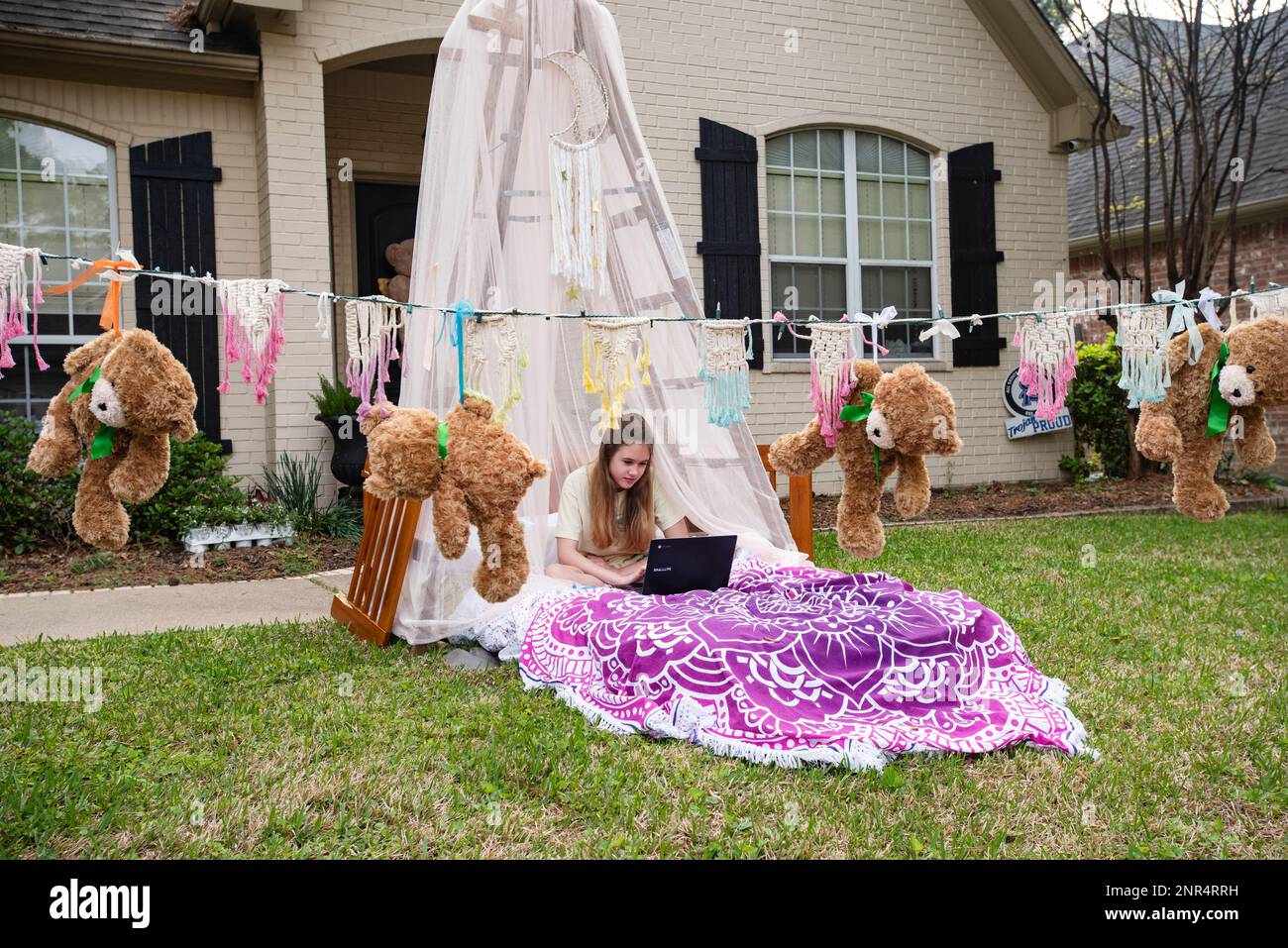 Clara Wyrick, 11, uses her laptop in her front yard while manning a ...