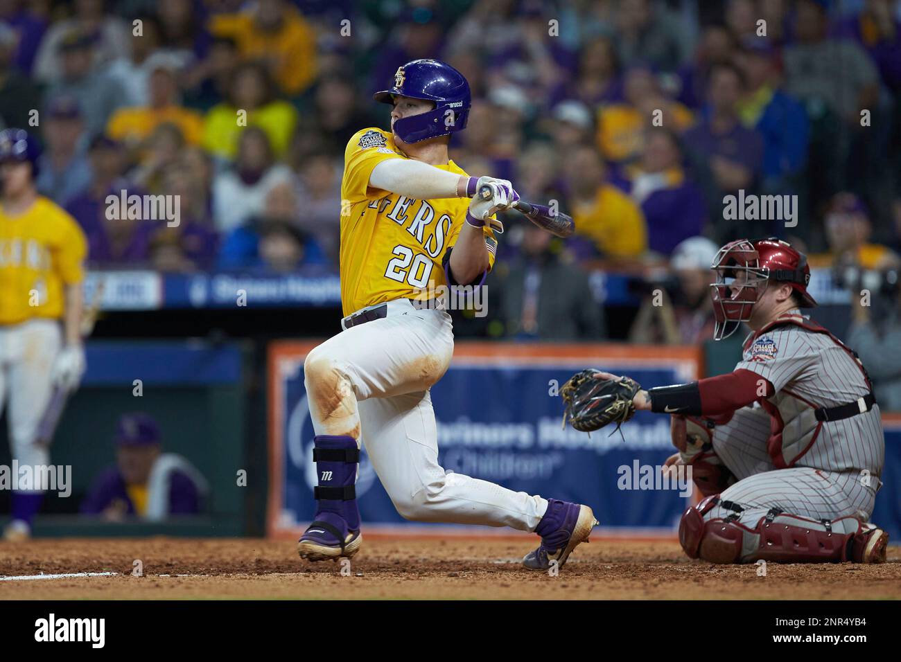 Alex Milazzo (20) of the LSU Tigers follows through on his swing ...