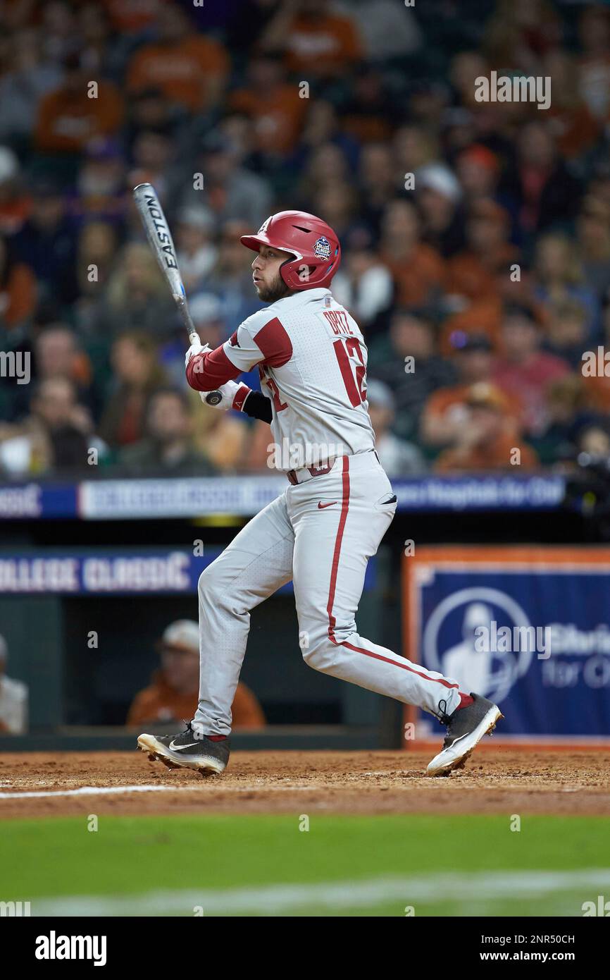 Casey Opitz (12) of the Arkansas Razorbacks follows through on his ...