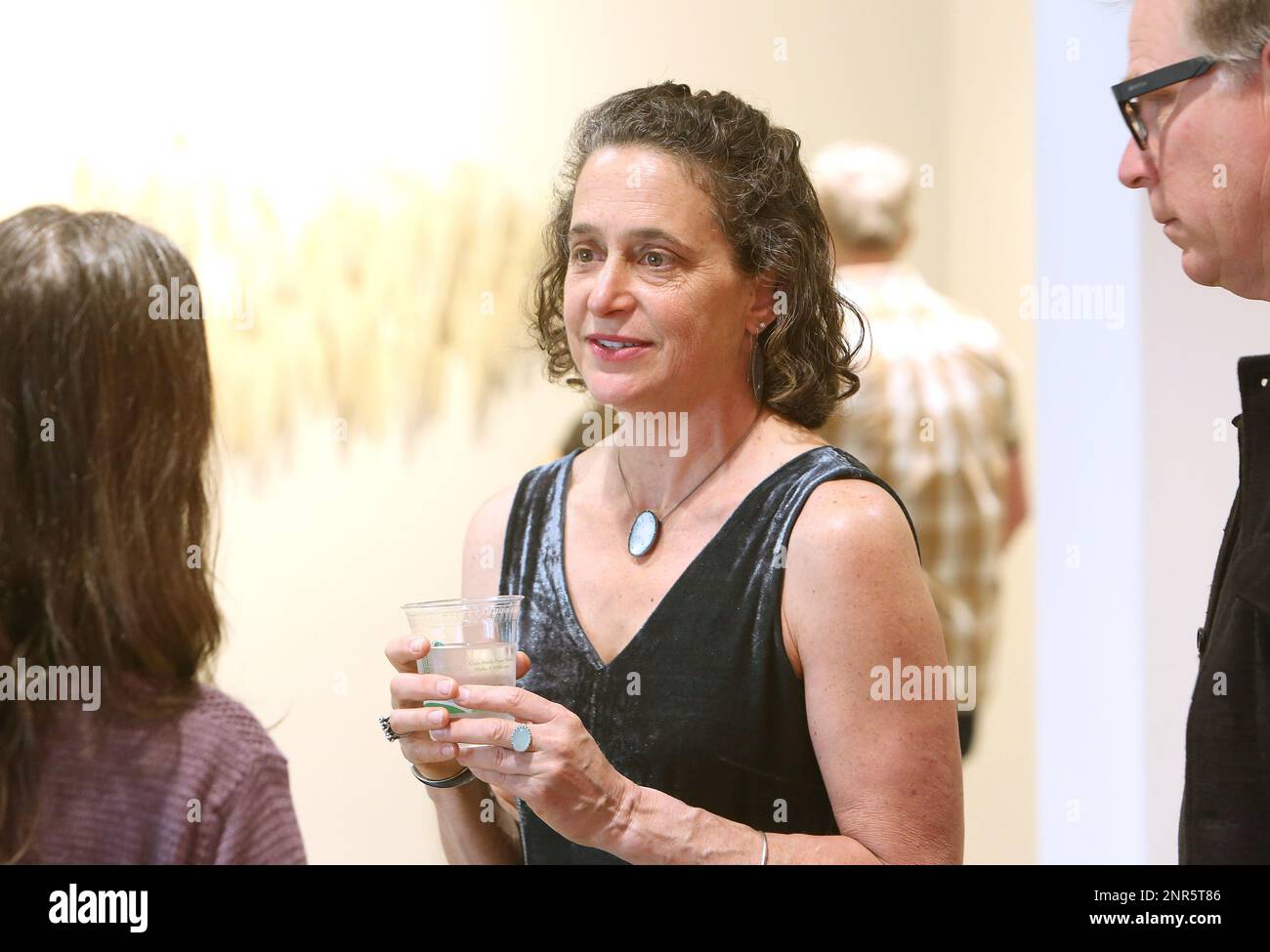Artist Nancy Mintz mingles with those in attendance of the opening of ...