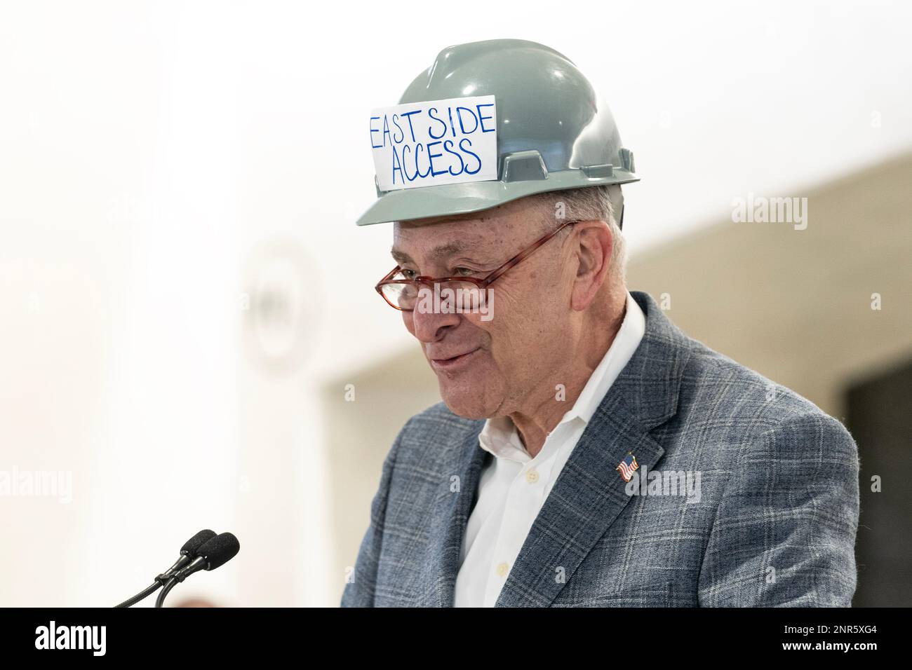 US Senator Charles Schumer speaks while wearing hard hat with sign East ...
