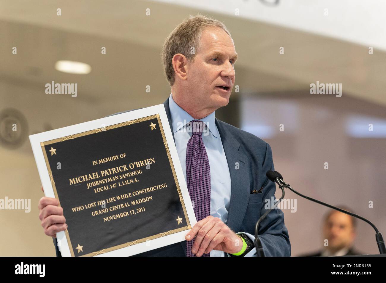 Janno Lieber, Chair and CEO of MTA speaks while holding a plaque to commemorate Michael Patrick ...