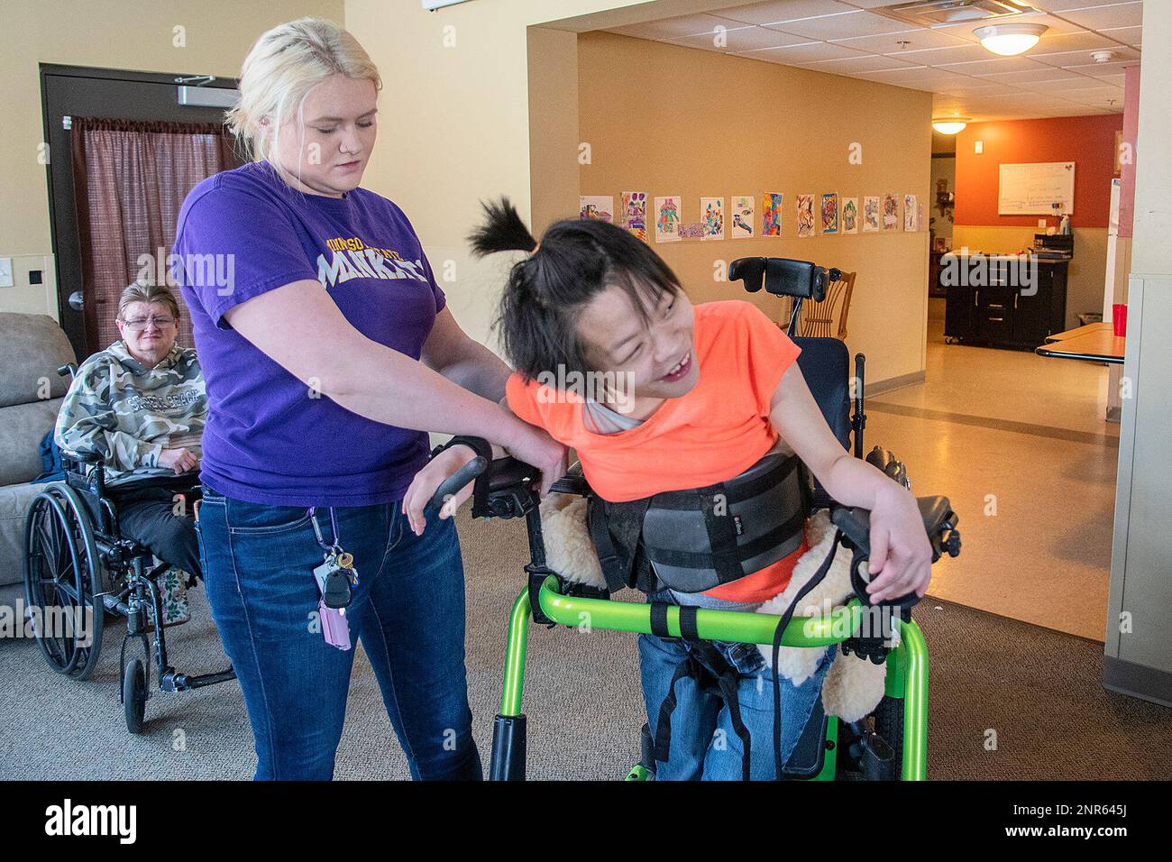 In this Feb. 27, 2020 photo, Wylie Rollings, left, helps Molly Owens into a walker from her ...