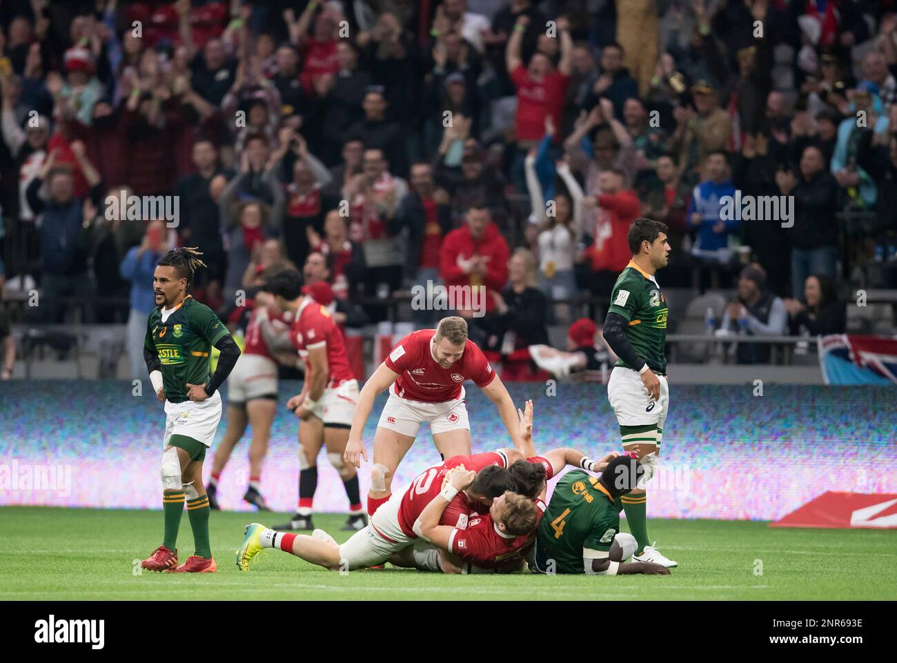 Canada's Jake Thiel, bottom center, is mobbed by his teammates after ...