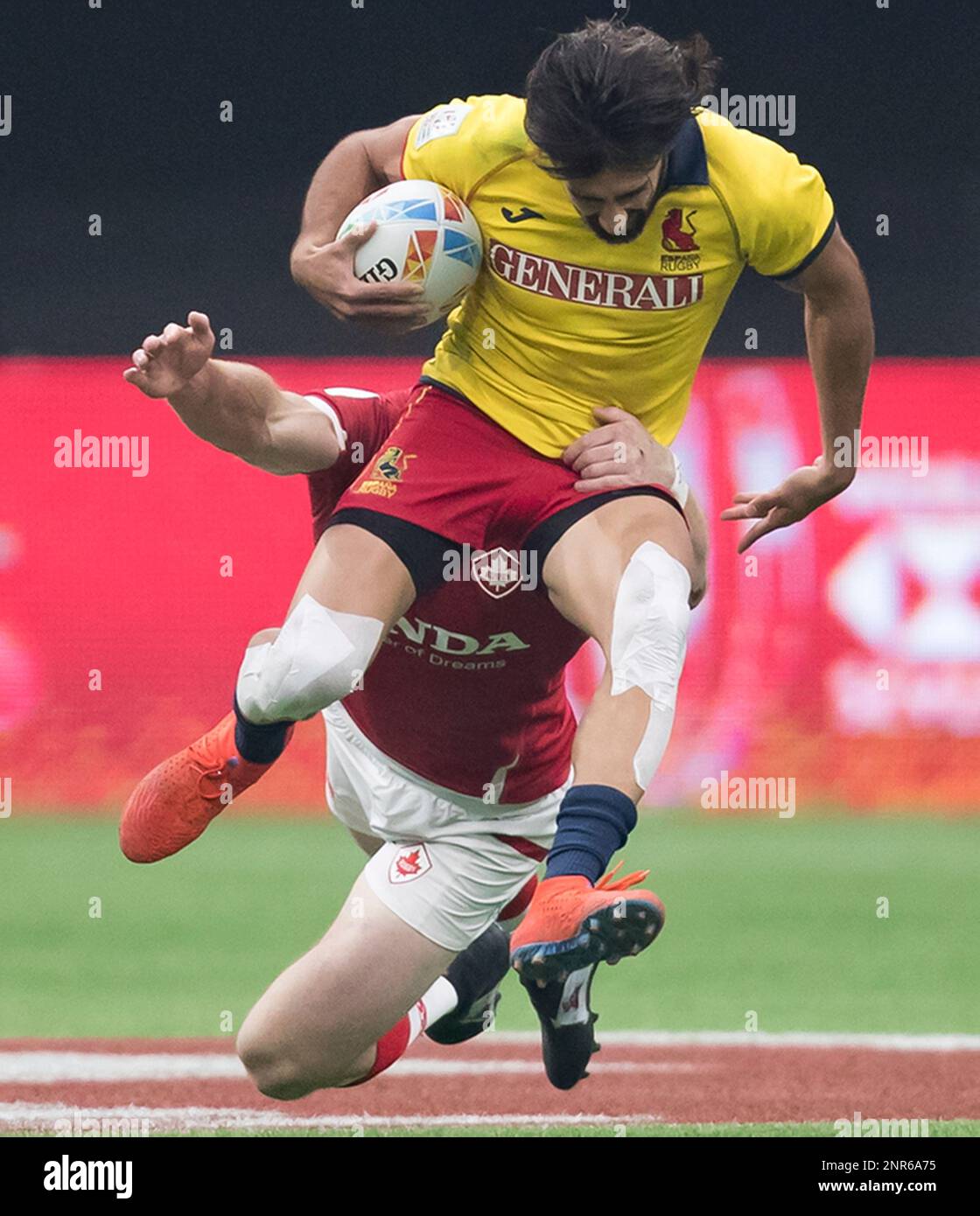 Spain's Pol Pla, front, is tackled by Canada's Connor Braid during a ...