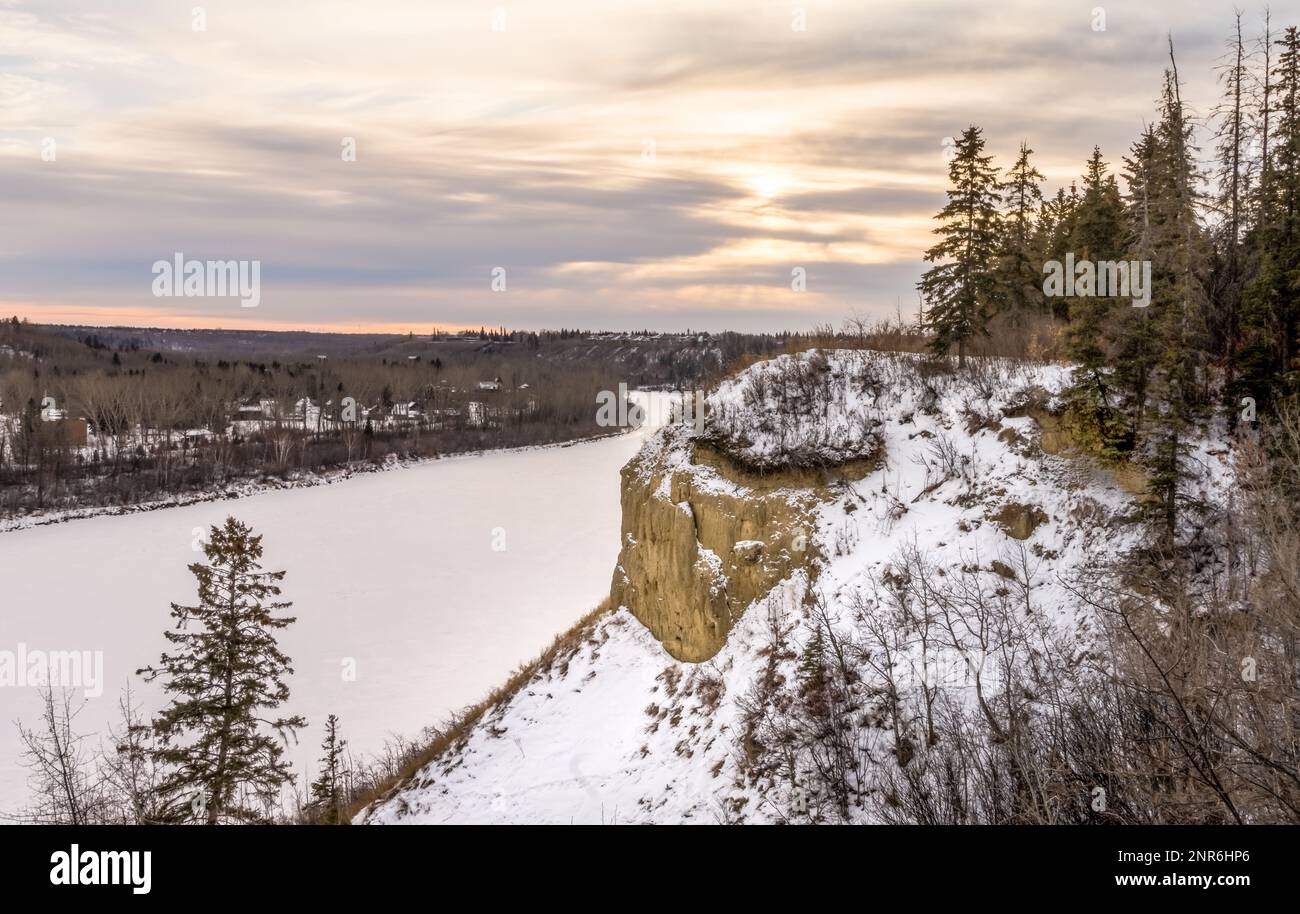 North Saskatchewan river steep bank with redish cloud sky background ...