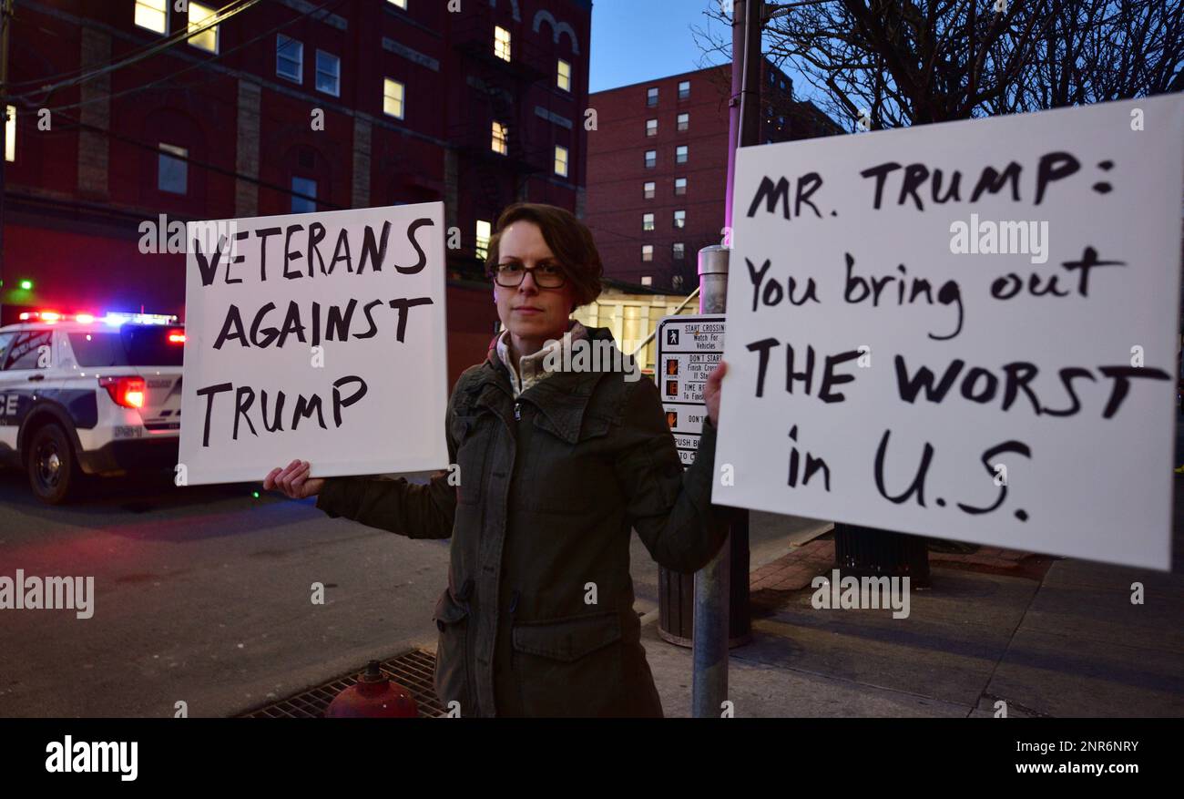 Erin Leach holds signs in protest of President Donald Trump who visited ...