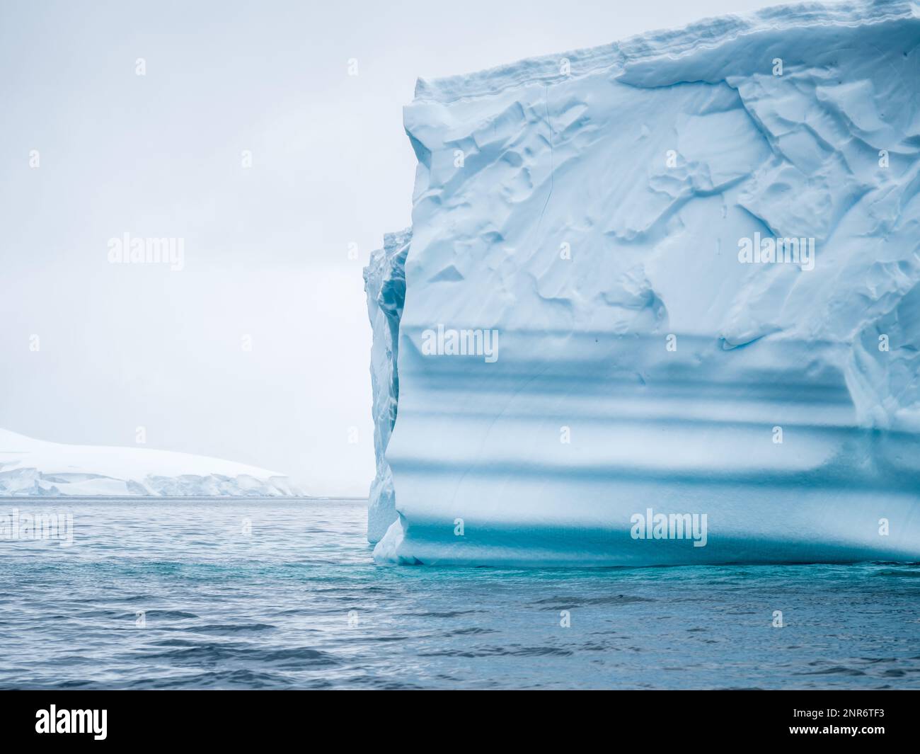 Layered iceberg in aqua water Stock Photo - Alamy