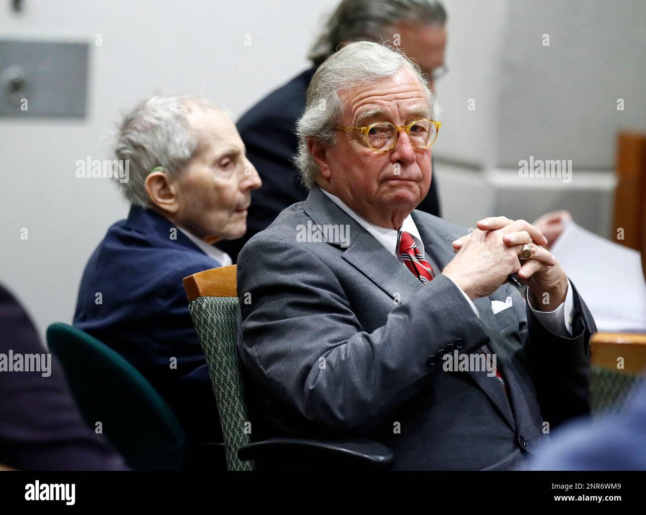 Defense attorney Dick DeGuerin, right, sits with his client real estate ...