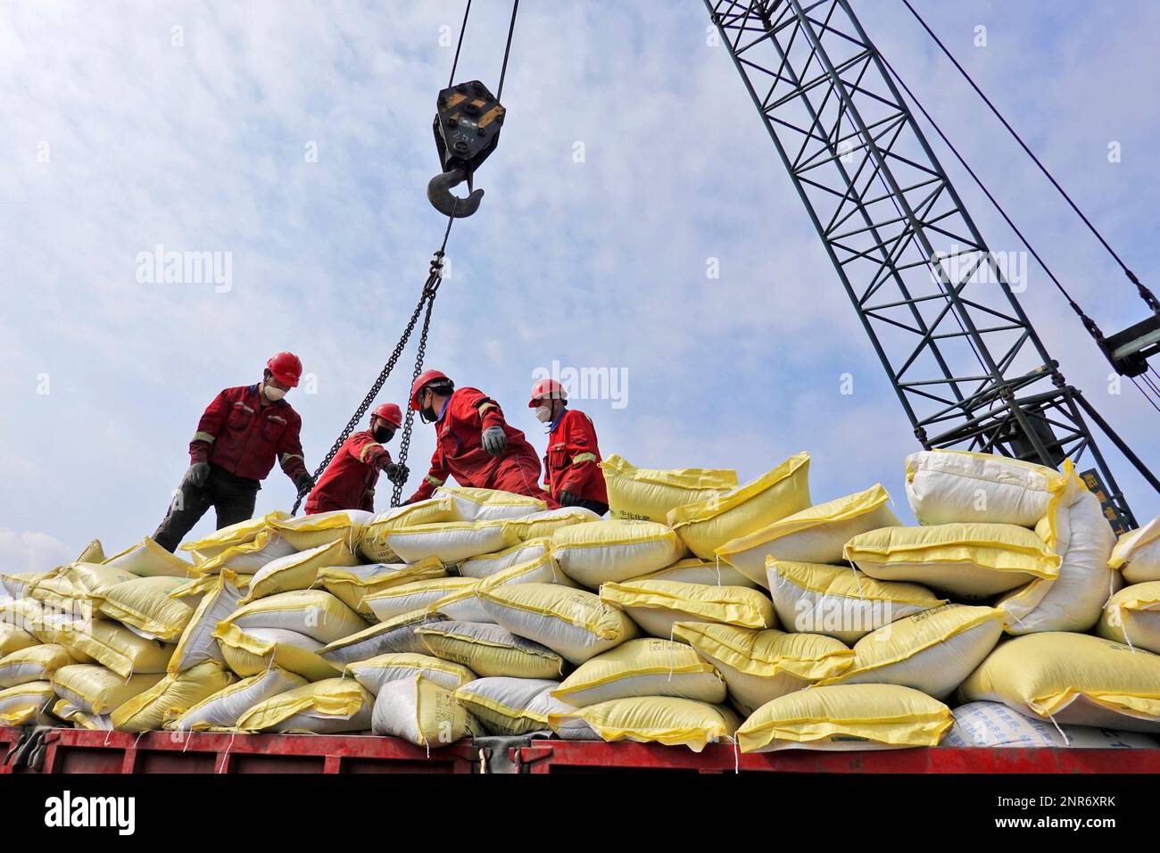 Workers load fertilizers for the northeastern provinces onto a ship in ...