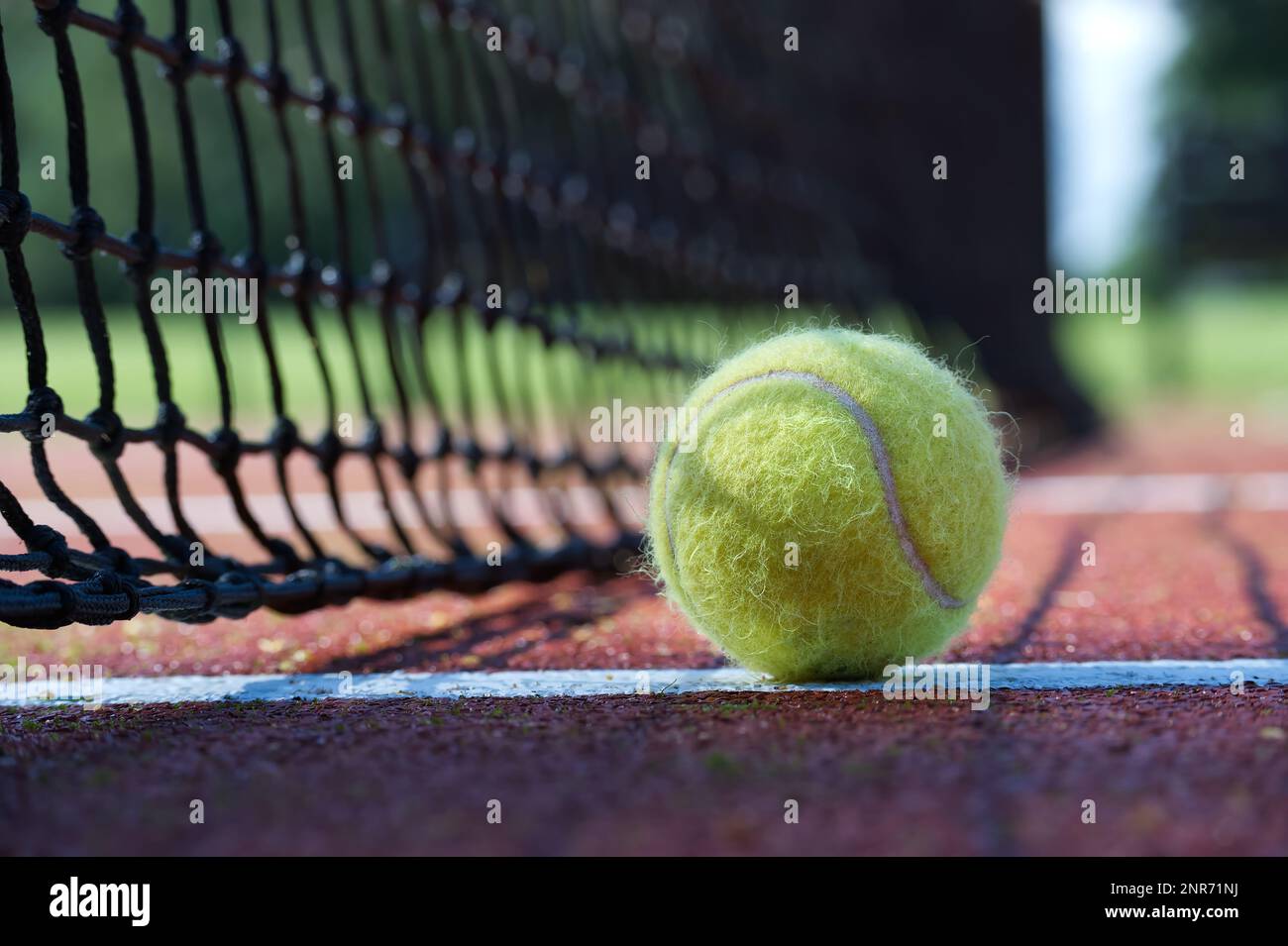 Tennis ball in the net. Ball hitting the tennis net, tennis scene with ...