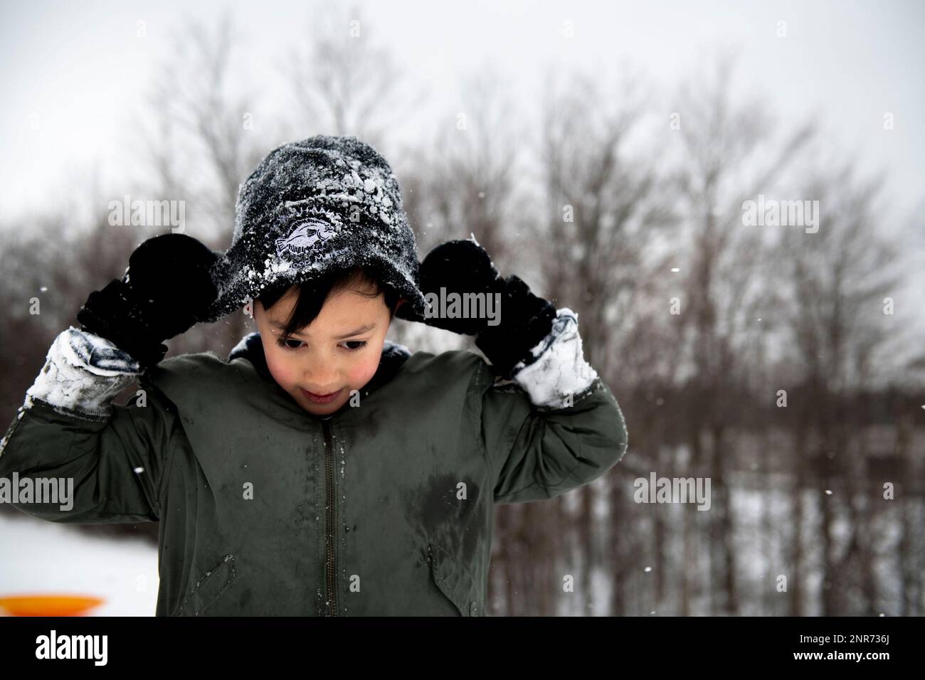 Charlie Monahan, 8, fixes his hat before sledding down the hill at ...