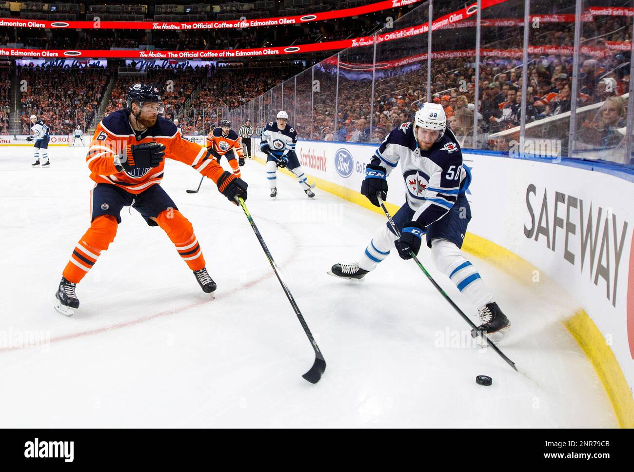 Winnipeg Jets' Jansen Harkins (58) reaches for the puck next to ...