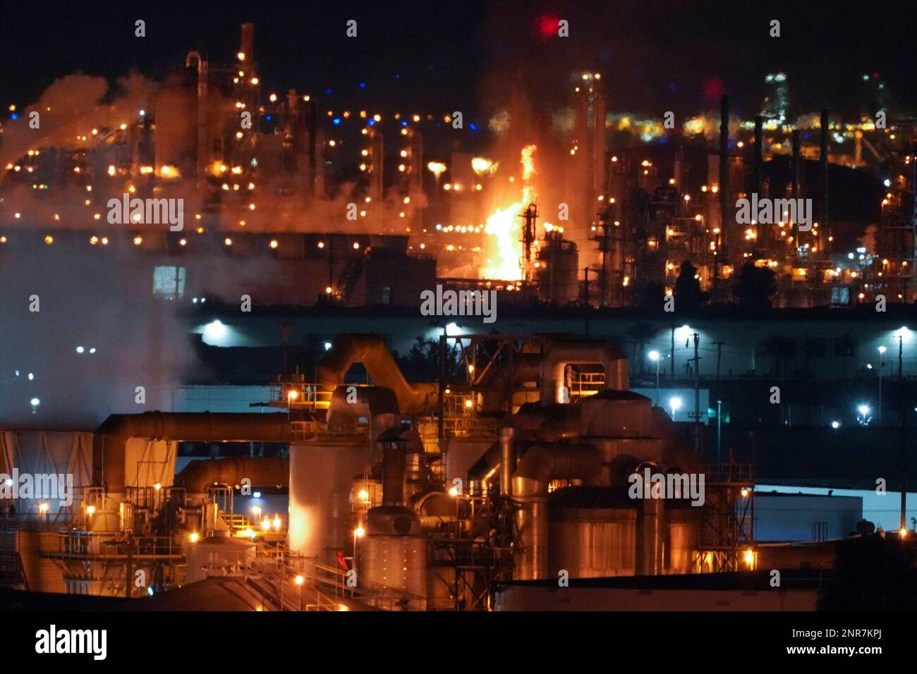 A fire burns after an explosion at the Marathon Refinery in Carson on ...