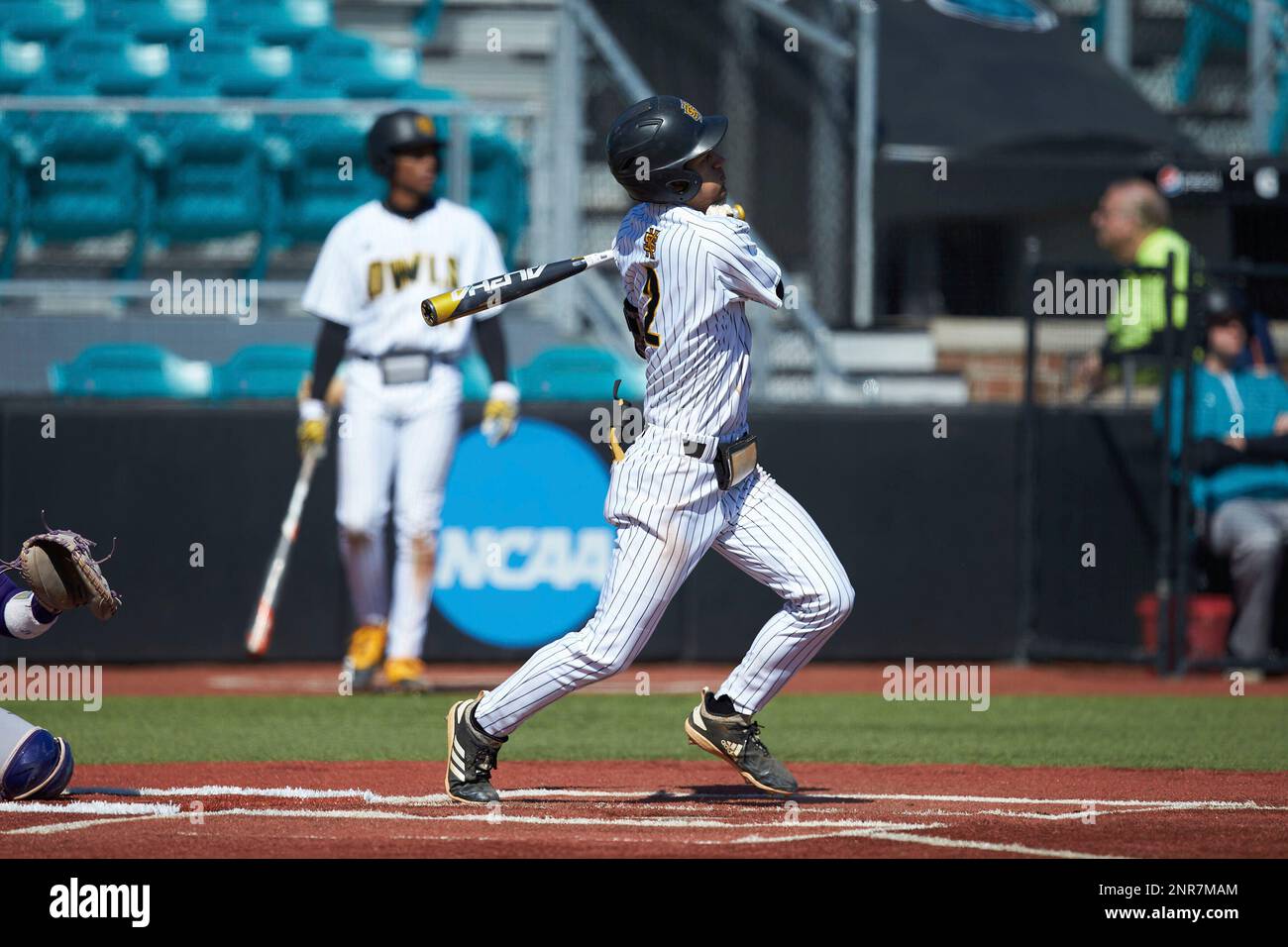 Tyler Simon (2) of the Kennesaw State Owls follows through on his swing ...