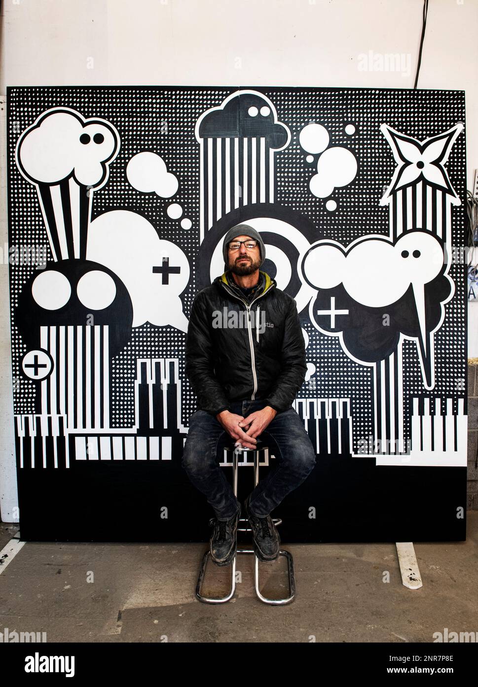 Chris Erickson poses in front of his billboard made for CORE's Imagine ...