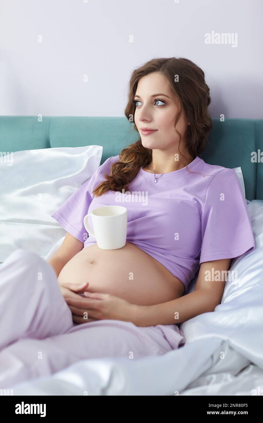 Beautiful woman in pajamas lies hi-res stock photography and images - Alamy