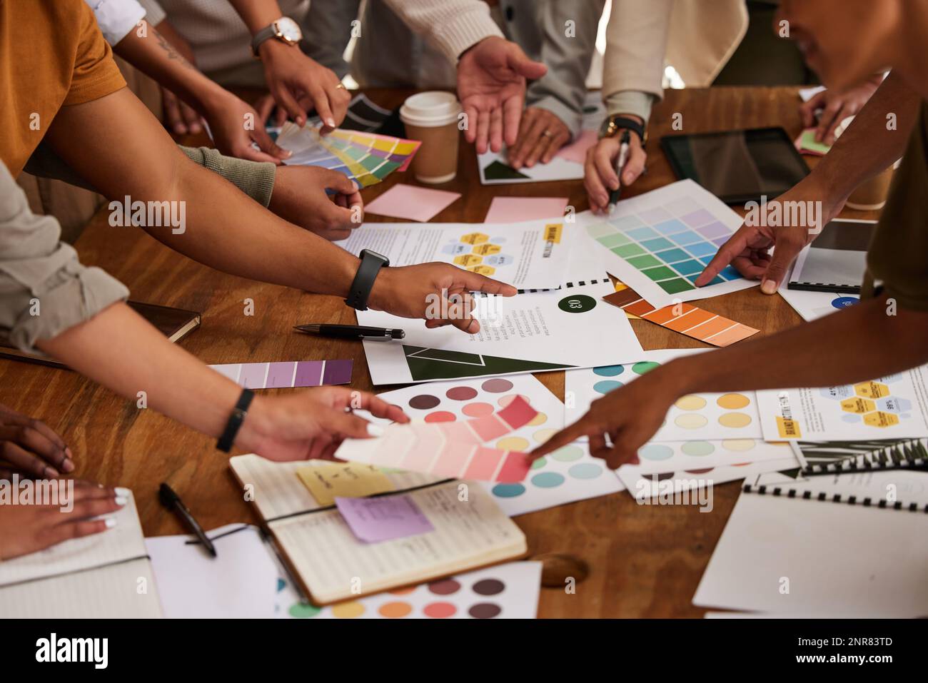 Creative, hands and color palette on table in meeting for planning ...