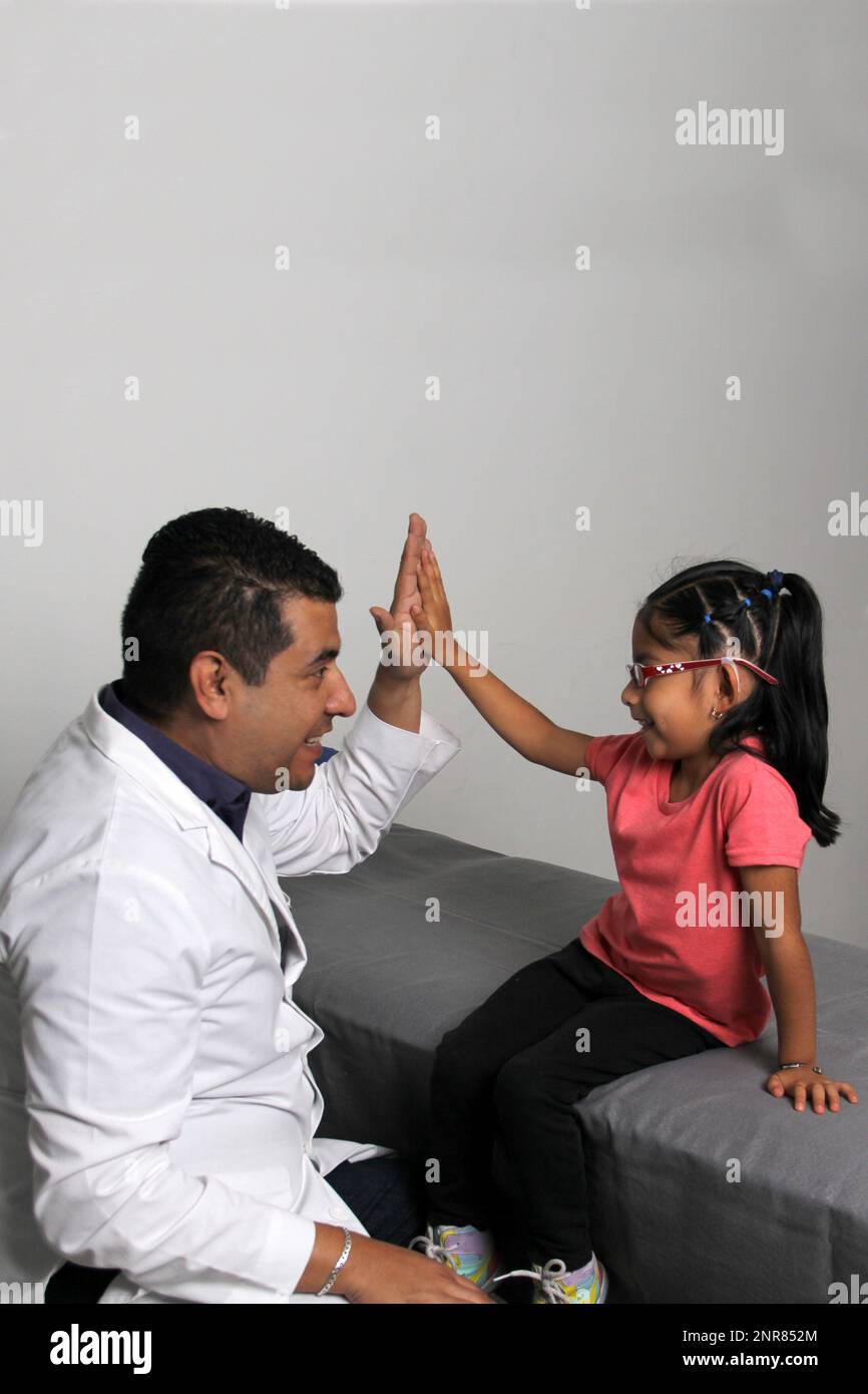 Pediatrician doctor and 4 year old latin girl patient in consultation ...