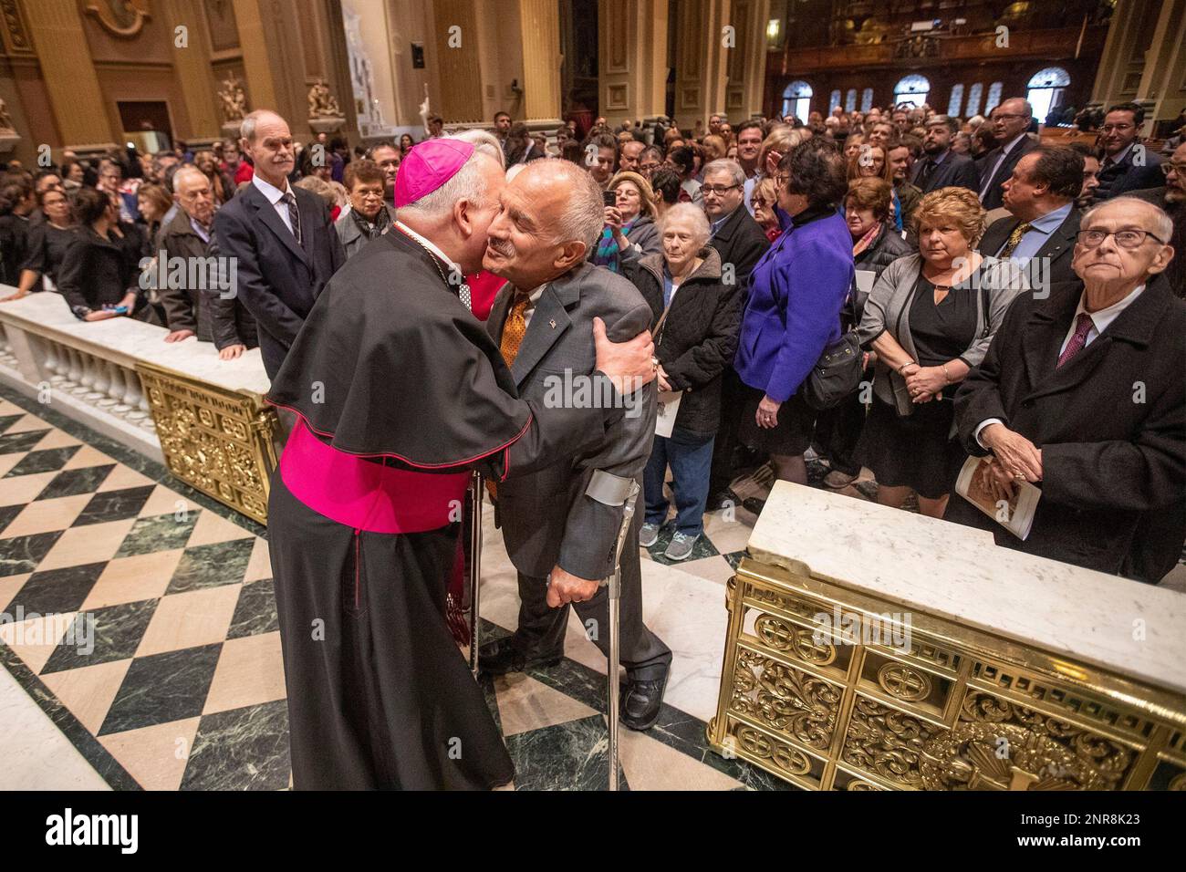 Robert Spinelli, right, of Scottsdale, Ariz., leans into a hug from the ...