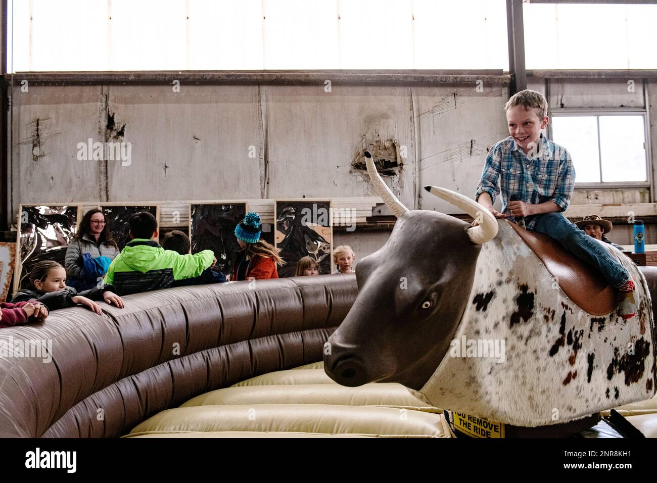 Memphis Enzer, 8, rides a mechanical bull at the Cozy Point Ranch ...