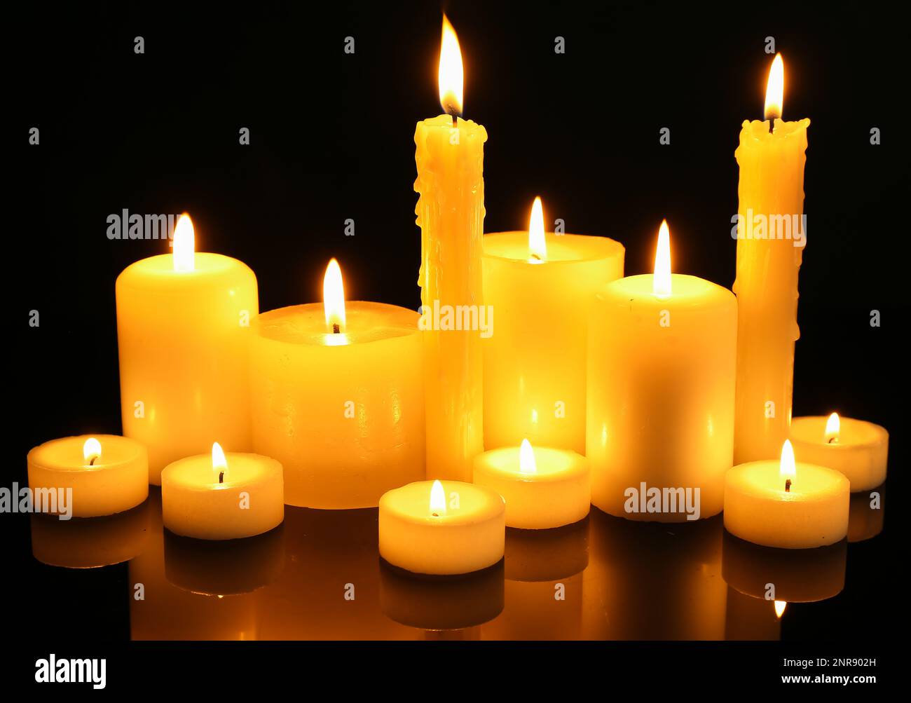 Burning candles on dark background. Mourning concept Stock Photo - Alamy