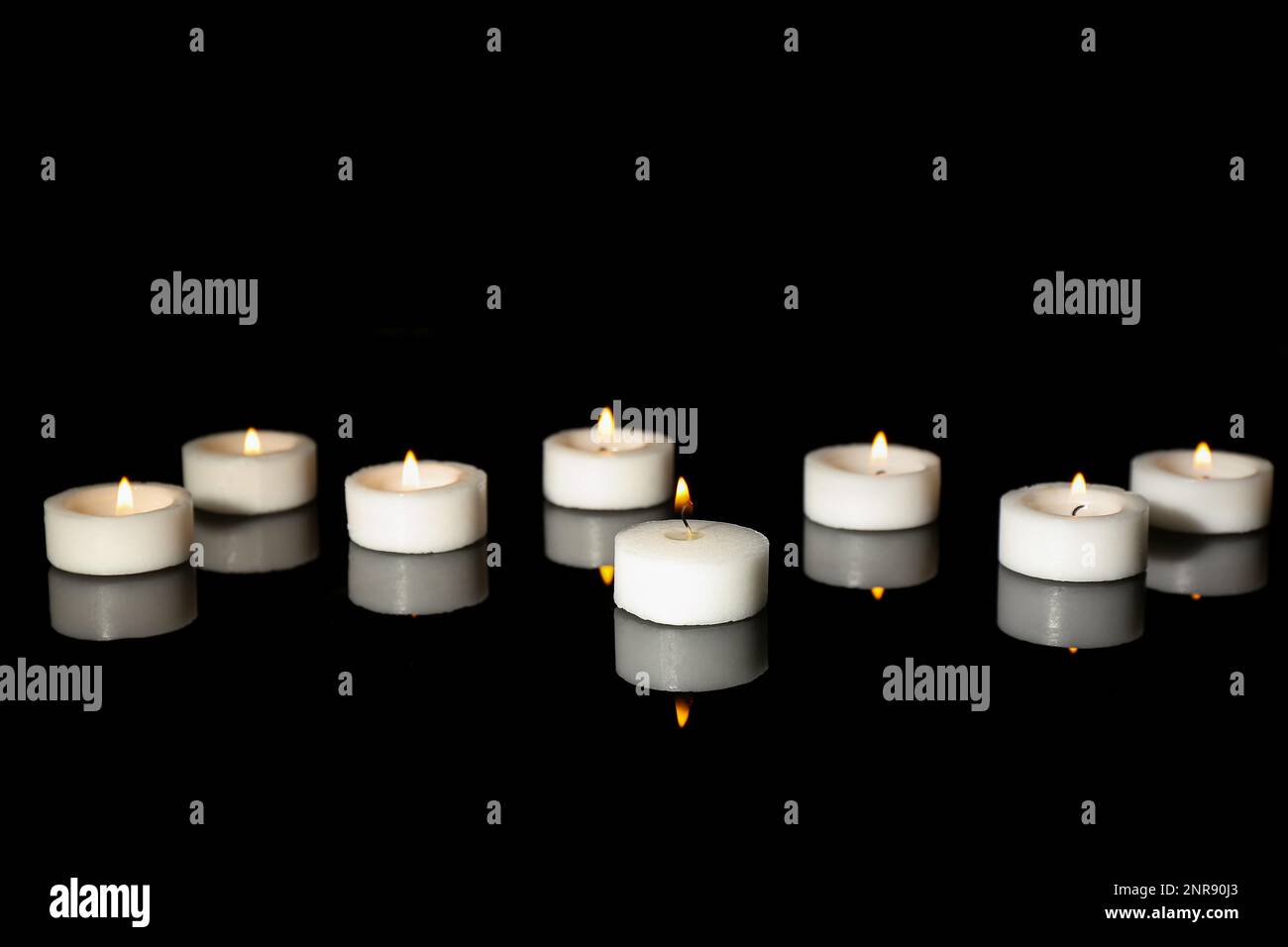 Burning candles on dark background. Mourning concept Stock Photo - Alamy