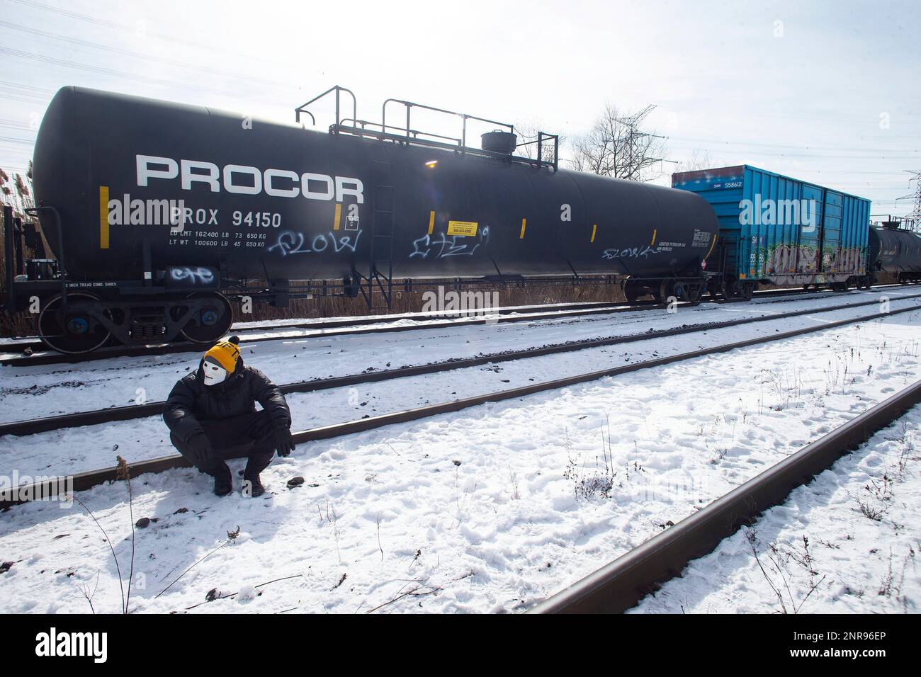 A protestor sits on train tracks during a blockade of the rail line at ...