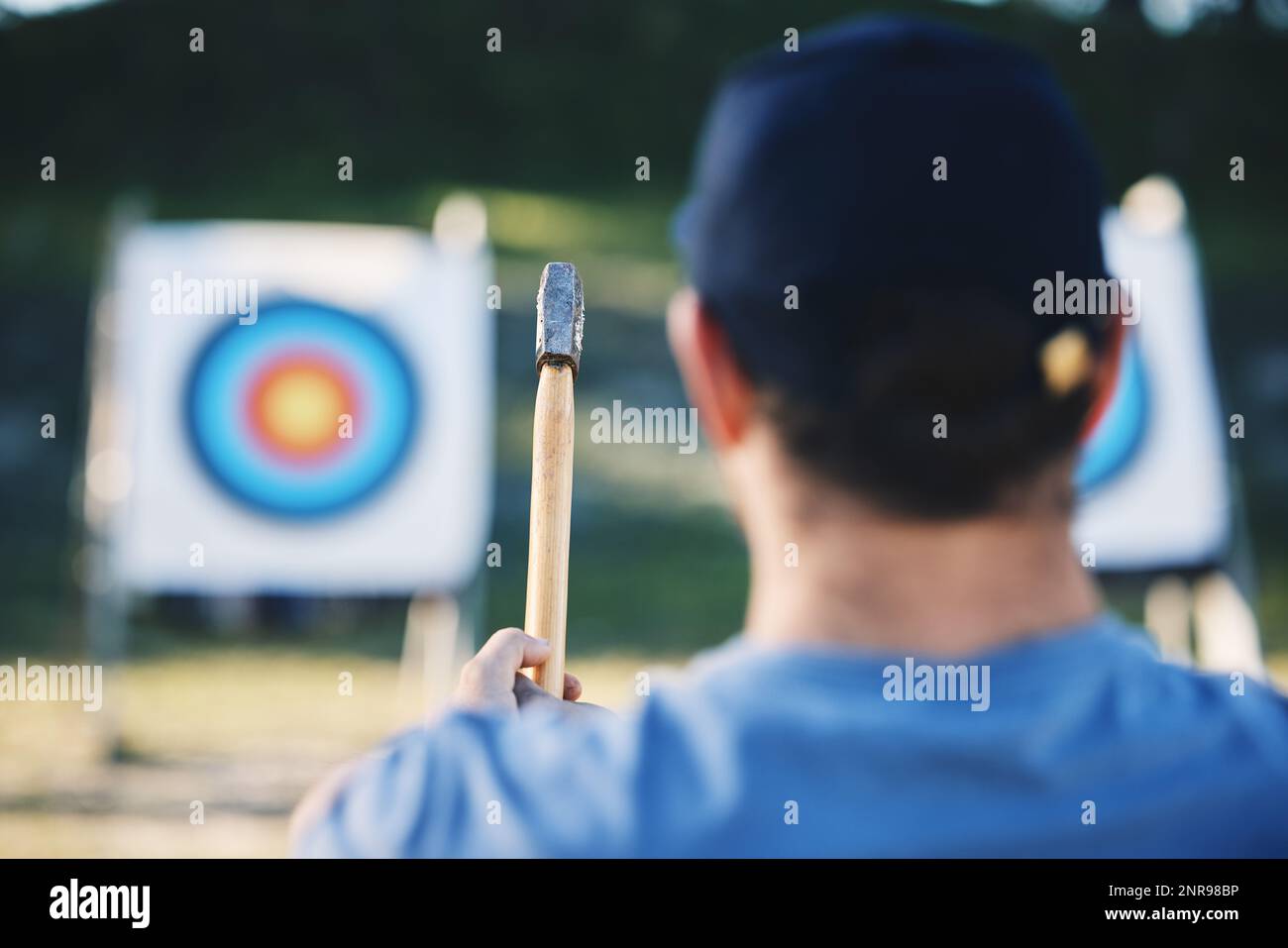 Sports, bullseye and man with axe for target on range for training ...