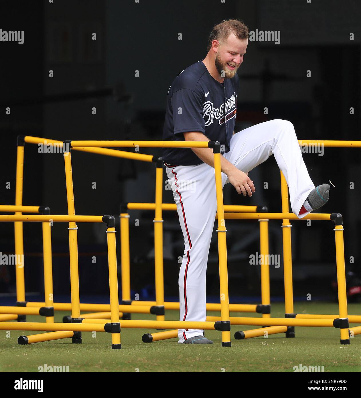 Atlanta Braves pitcher A.J. Minter does an agility drill at baseball ...