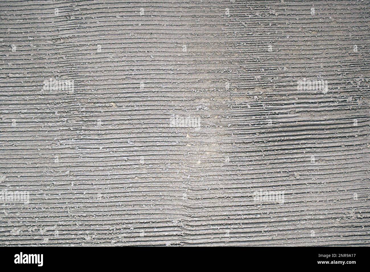 Gray decorative plaster on the wall with pressed horizontal stripes ...
