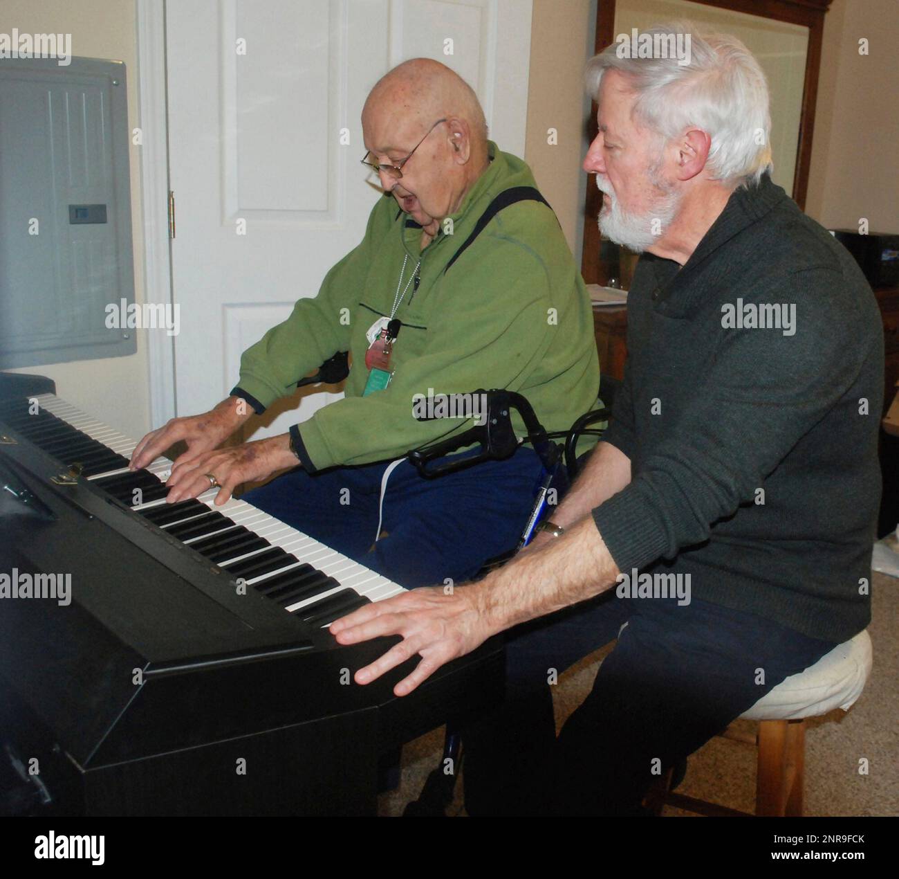 Bob Olsen, left, and Tom Adamson, both of Fremont, sit at the piano ...