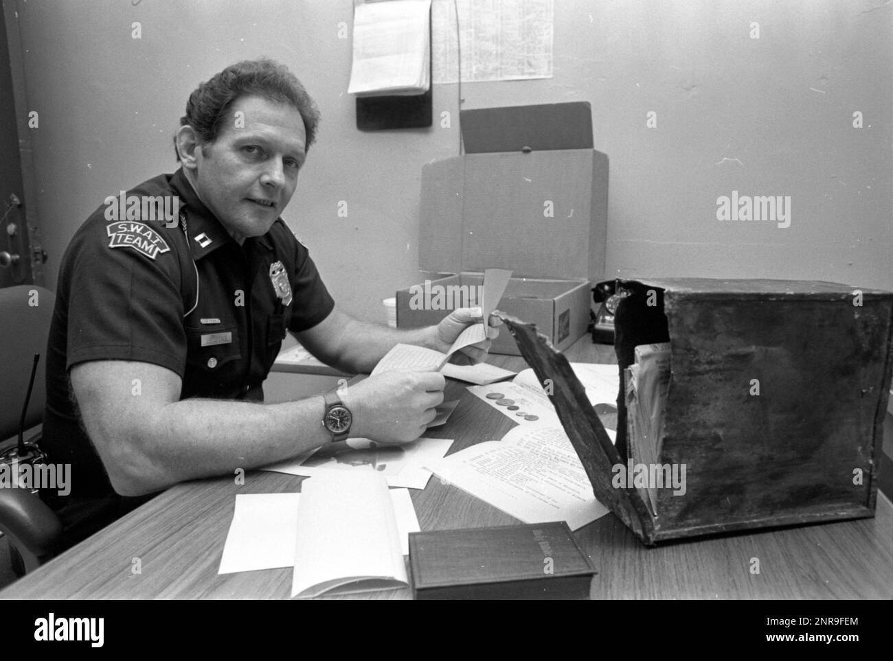 Atlanta police officer Julian Spence looks over the contents of a time ...