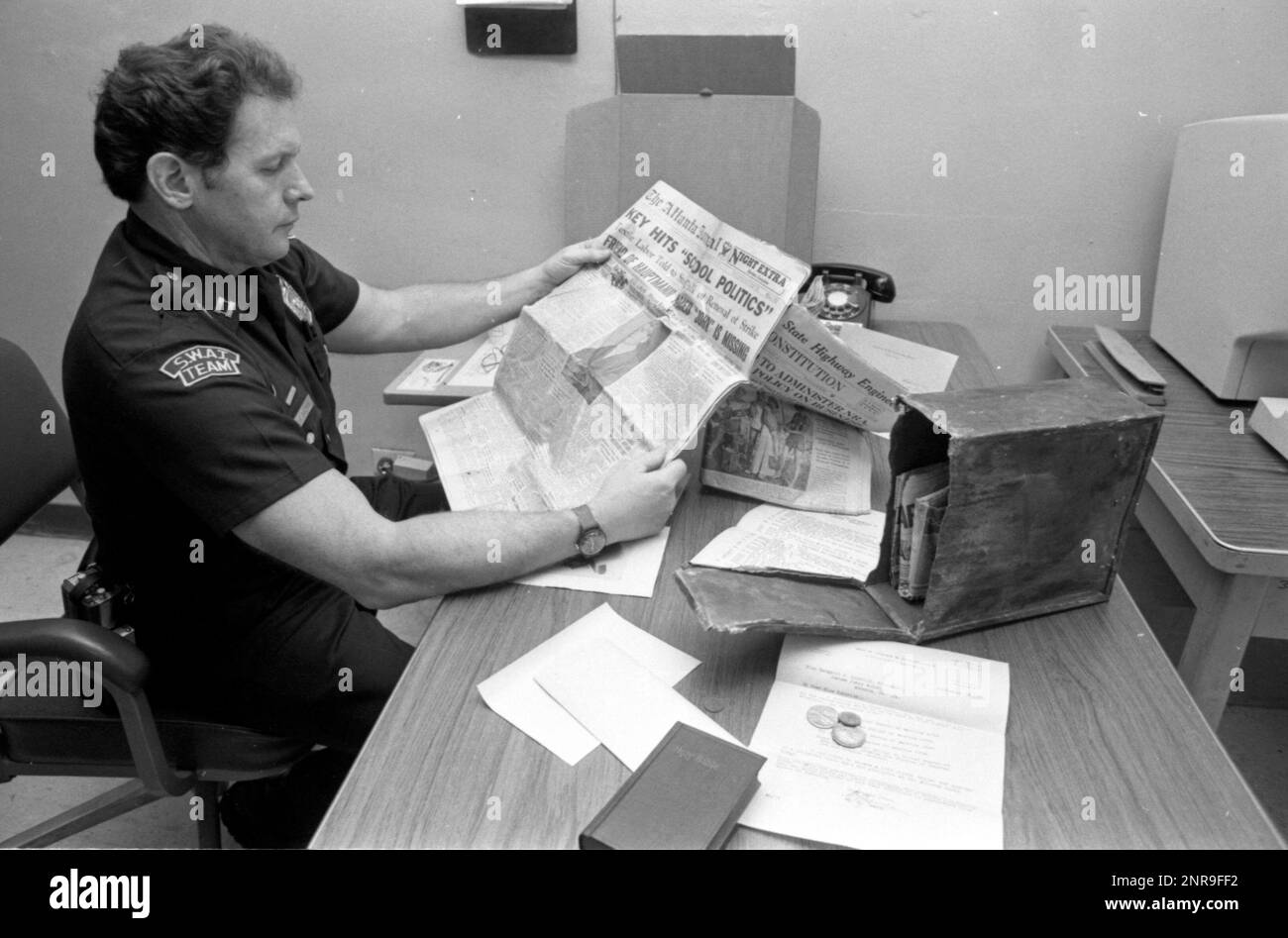 Atlanta police officer Julian Spence looks over the contents of a time ...
