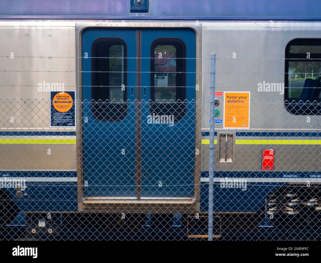 Train In Yard Behind Wire Fence Stock Photo - Alamy