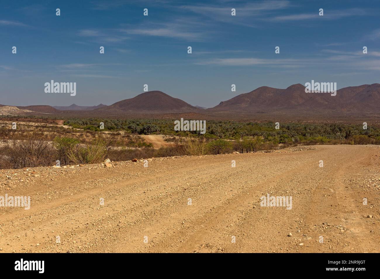 The dusty gravel road along the Kunene River in northern Namibia Stock ...