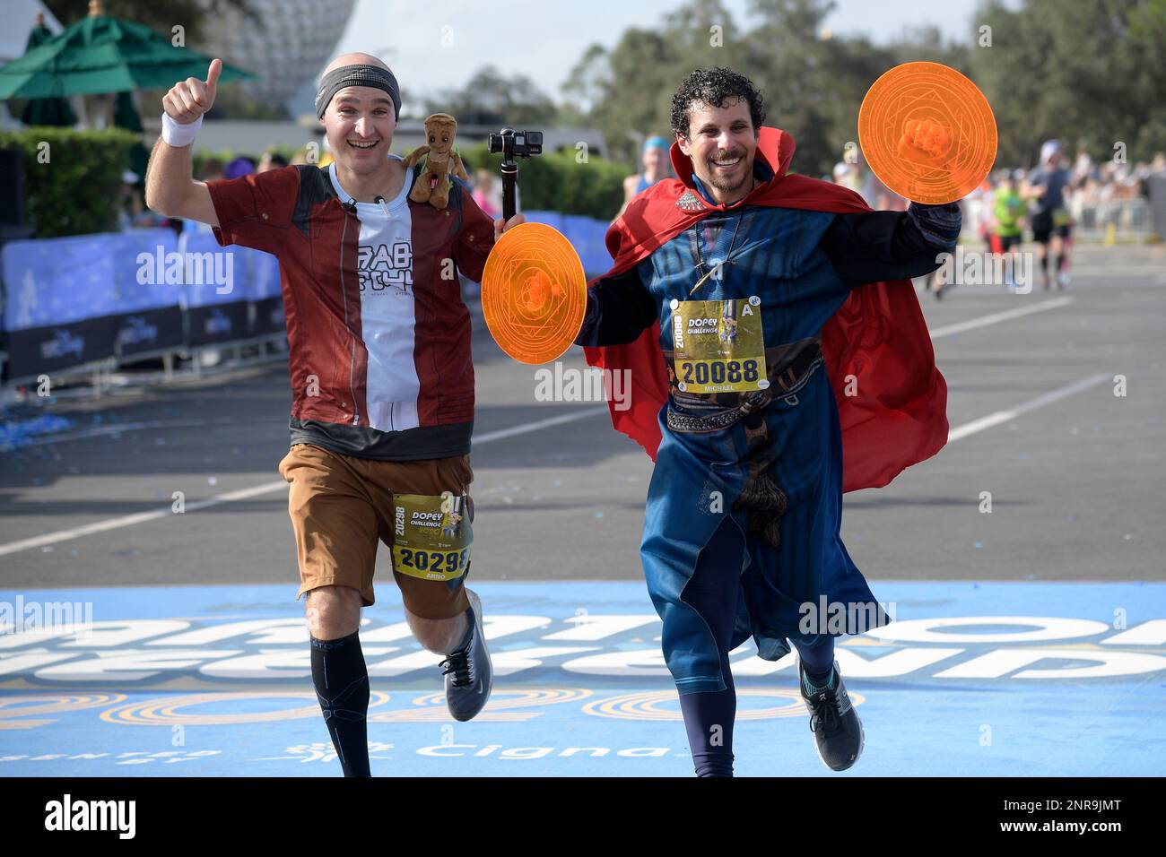 Runners cross the finish line during the Walt Disney World Marathon ...