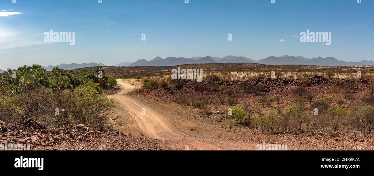 The dusty gravel road along the Kunene River in northern Namibia Stock ...