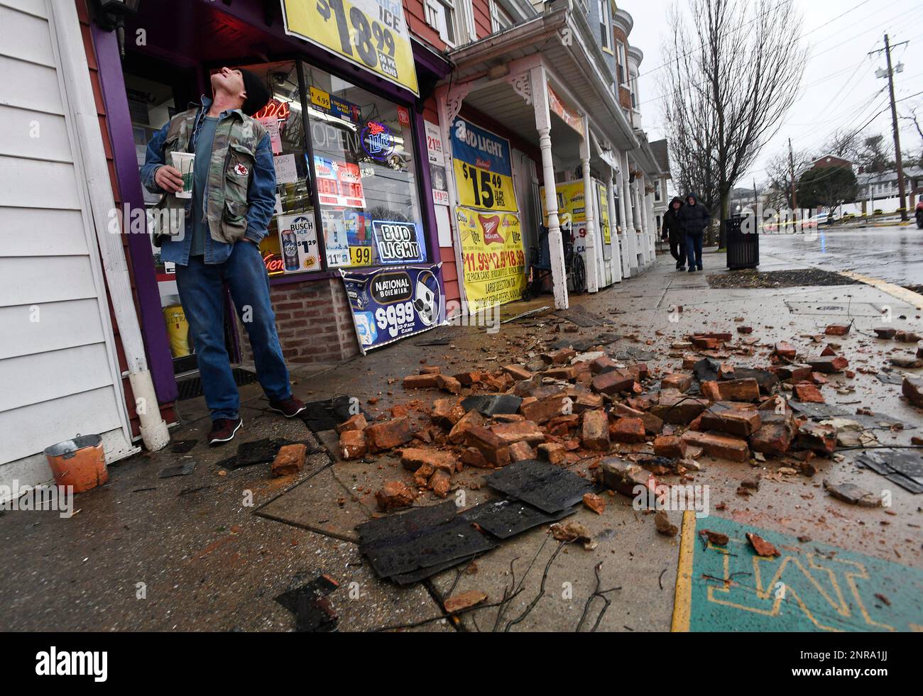 Terry Humple looks at roof damage above Carriage House Liquors on West ...
